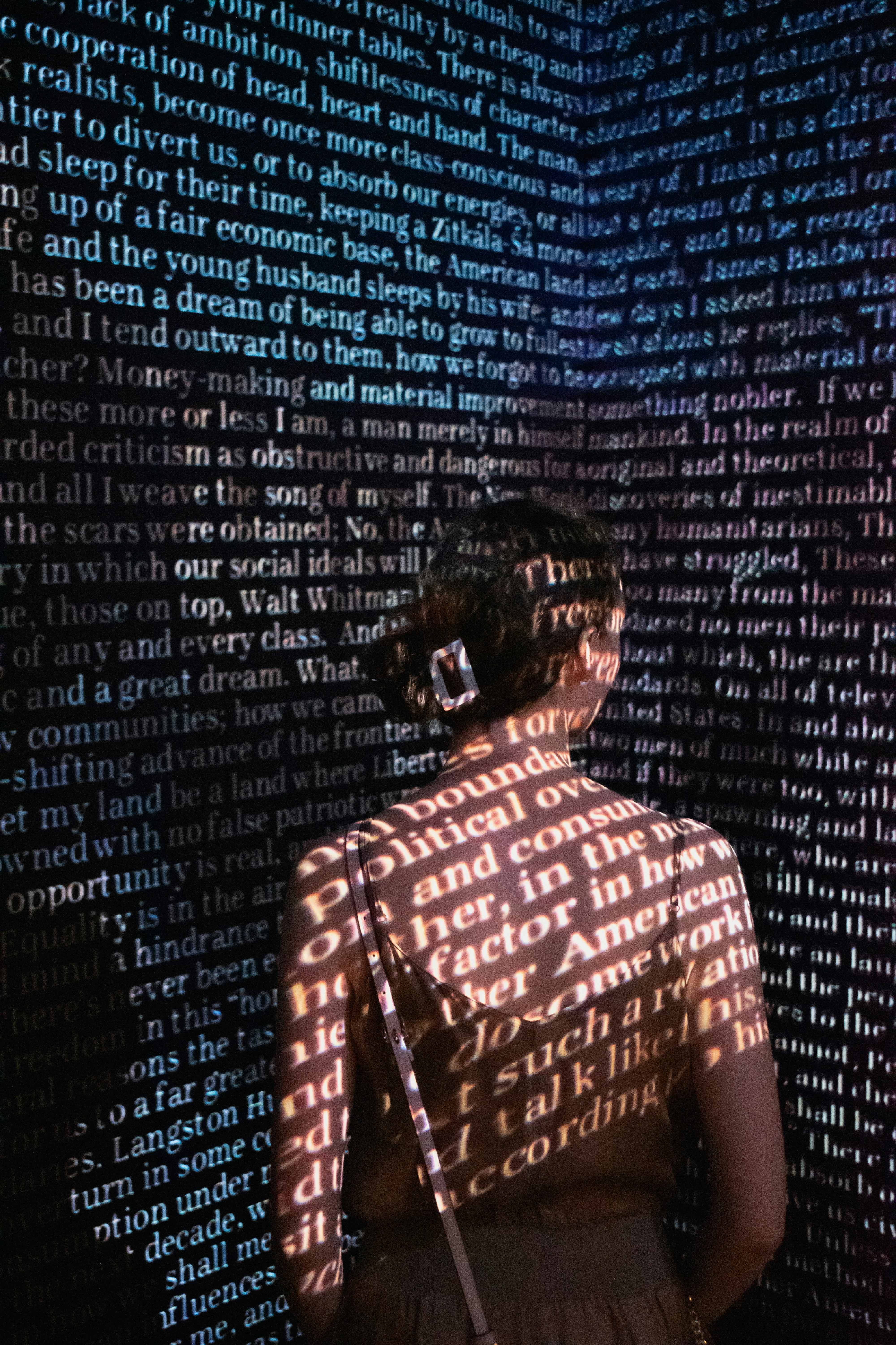 Projected Words, Hidden Identity: a backturned portrait in a wall of text