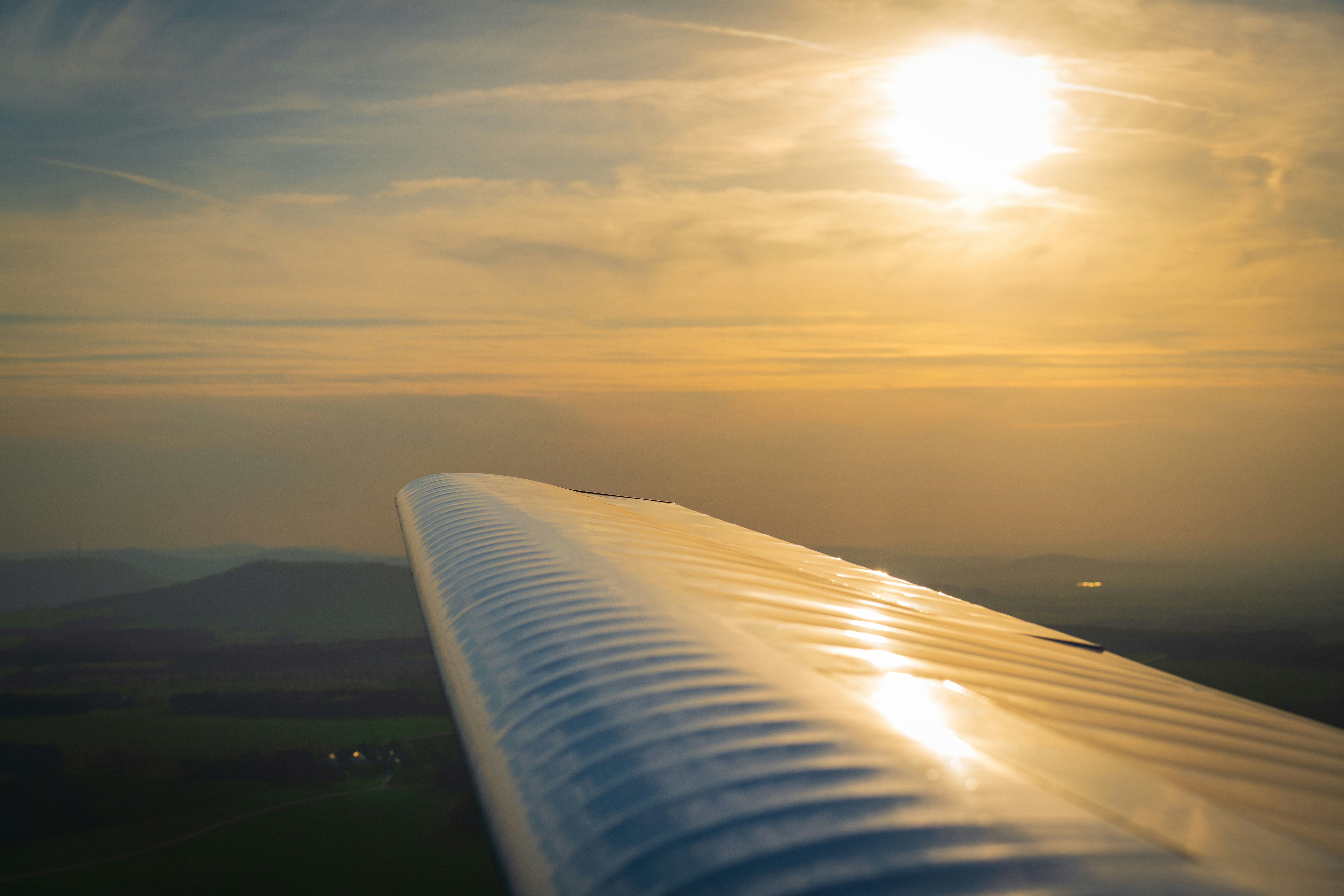 Wing in Golden Hour: Aerial Light Tracing a Quiet Horizon