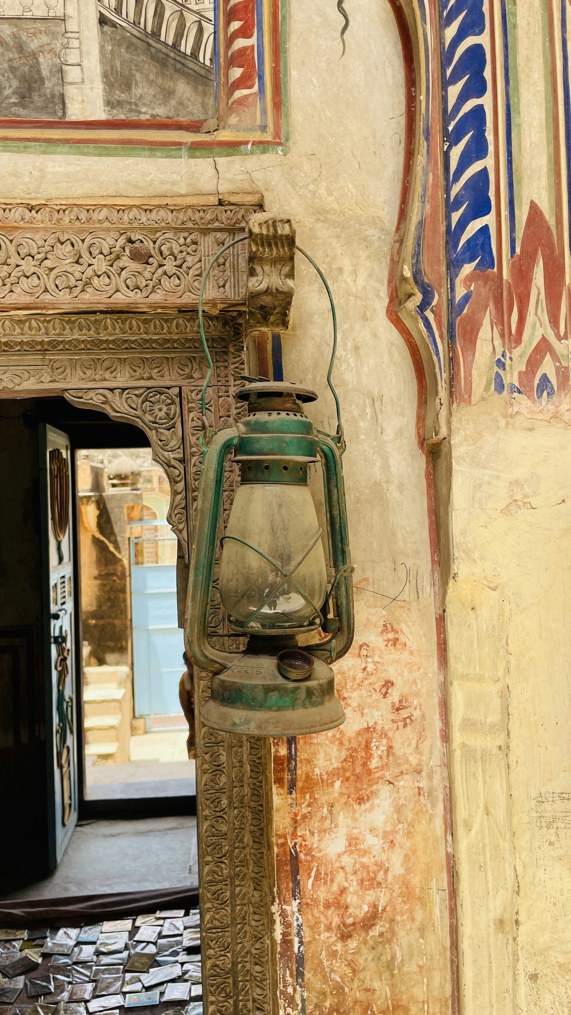 Lantern on a Carved Archway Under Warm Sunlight