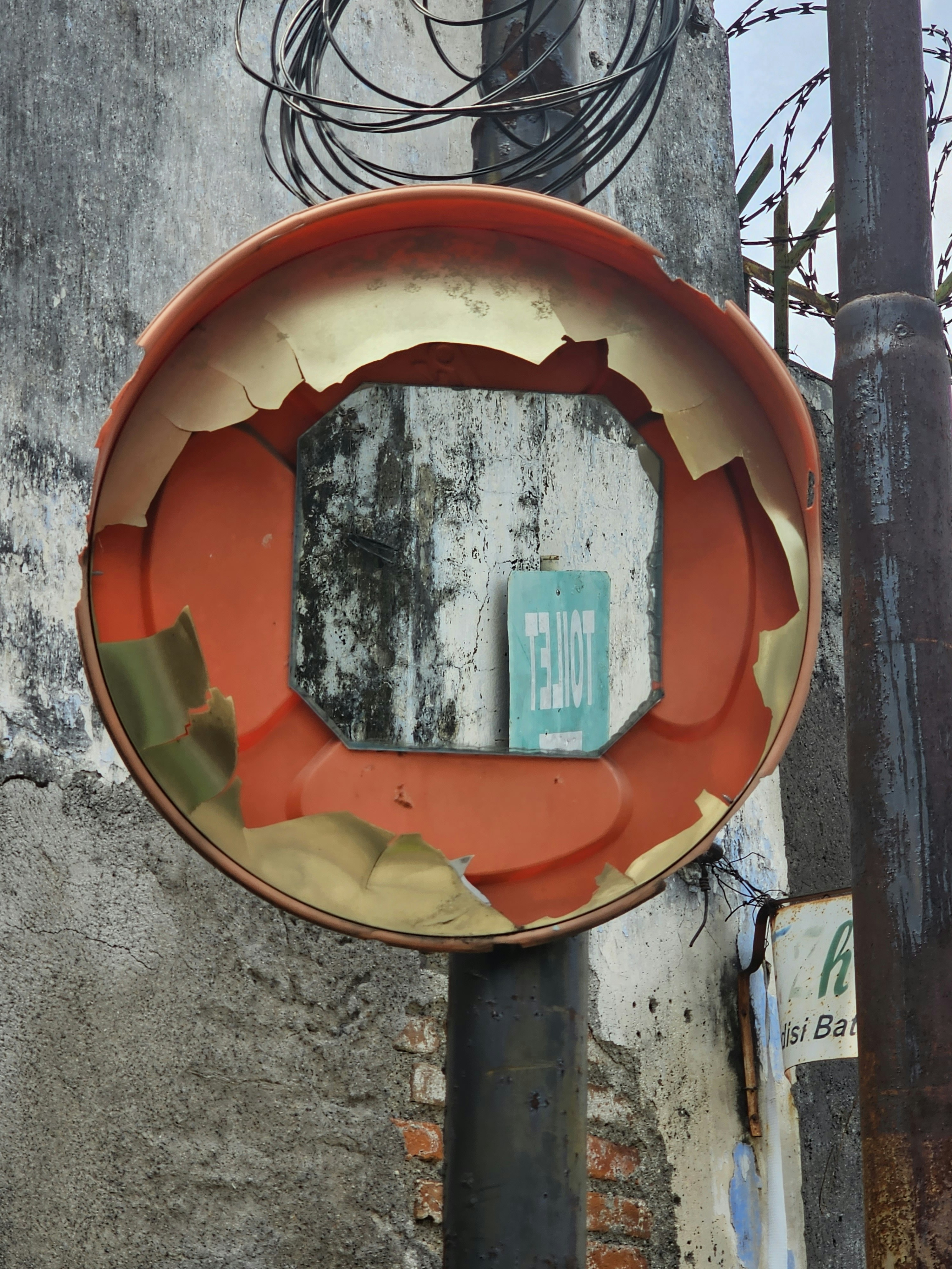 Peeling Orange Ring Framing a Weathered Exit