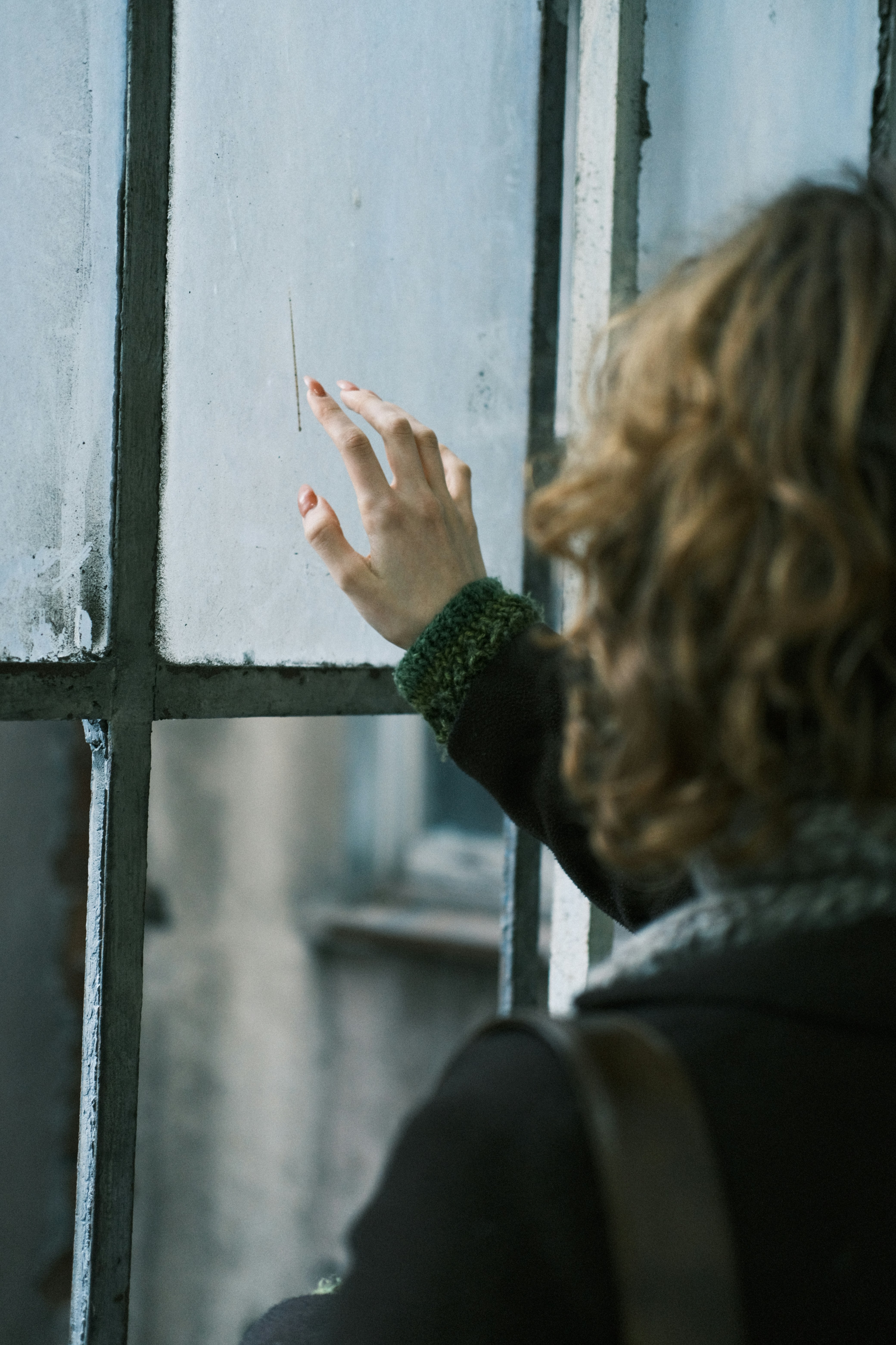 Gloved Reach: A Quiet Moment at the Windowsill