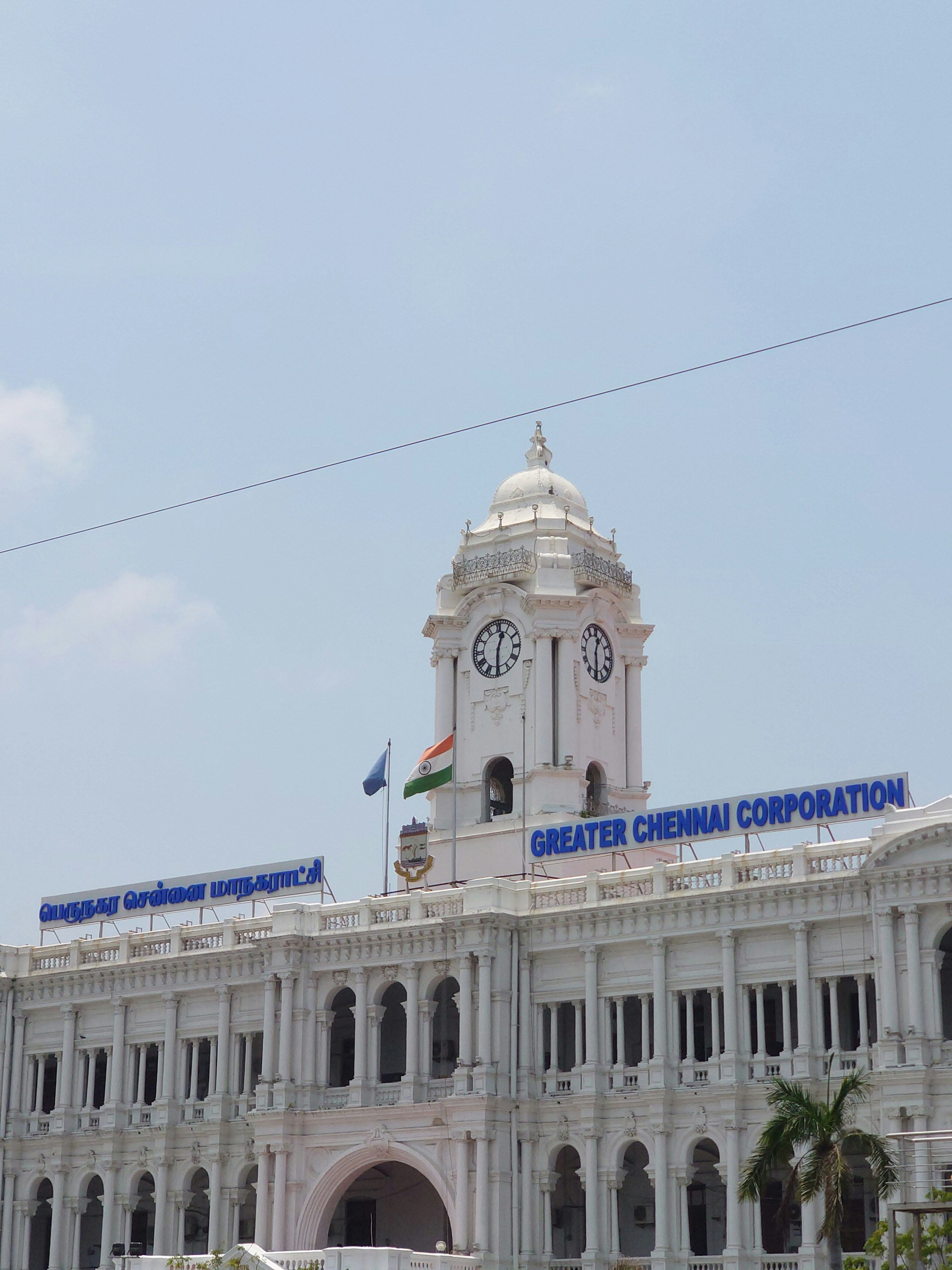 The iconic clock tower of the Greater Chennai Corporation stands tall against a clear blue sky, showcasing its architectural grandeur and historical significance.