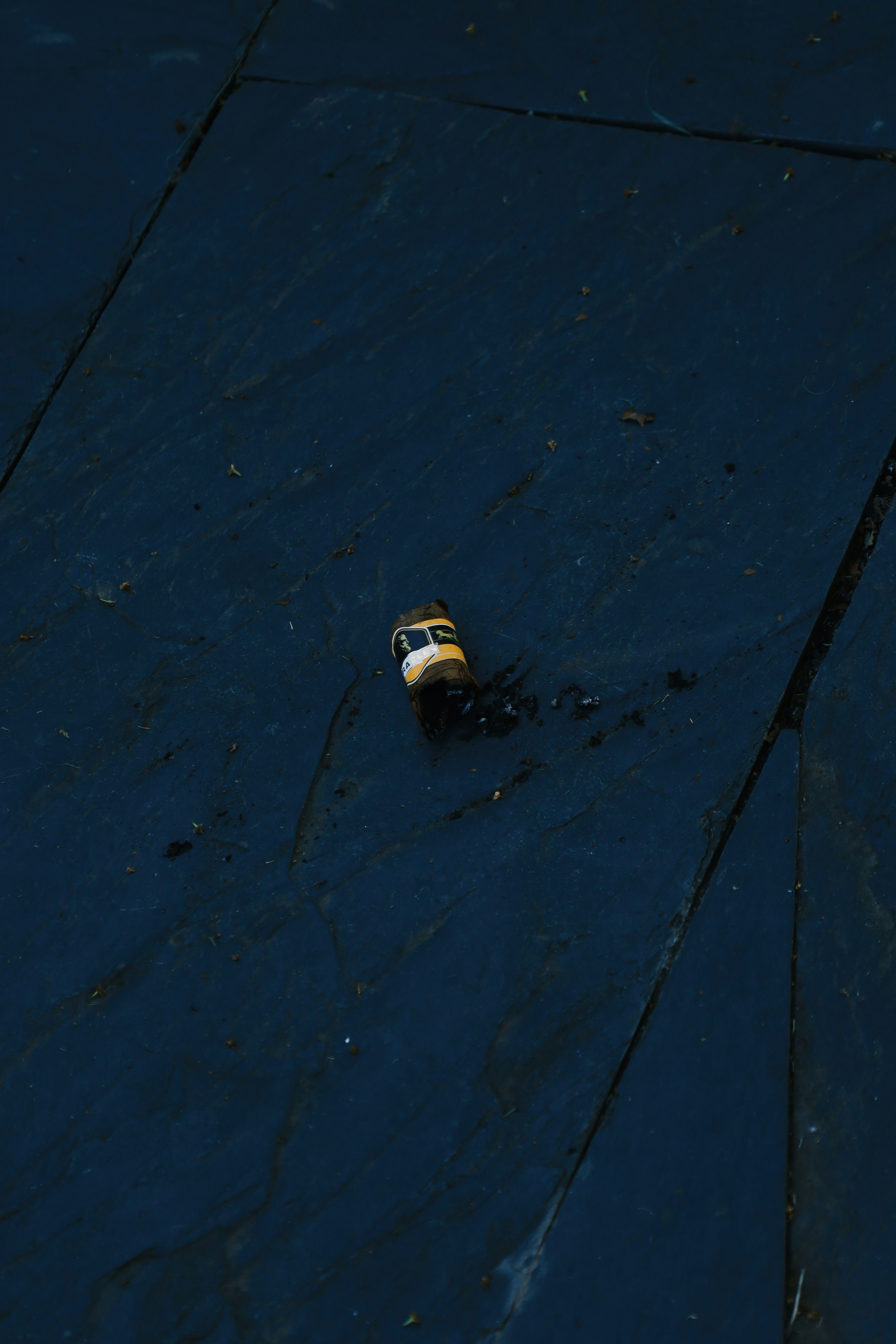 Lone Yellow Cap Adrift on a Moody Blue Deck