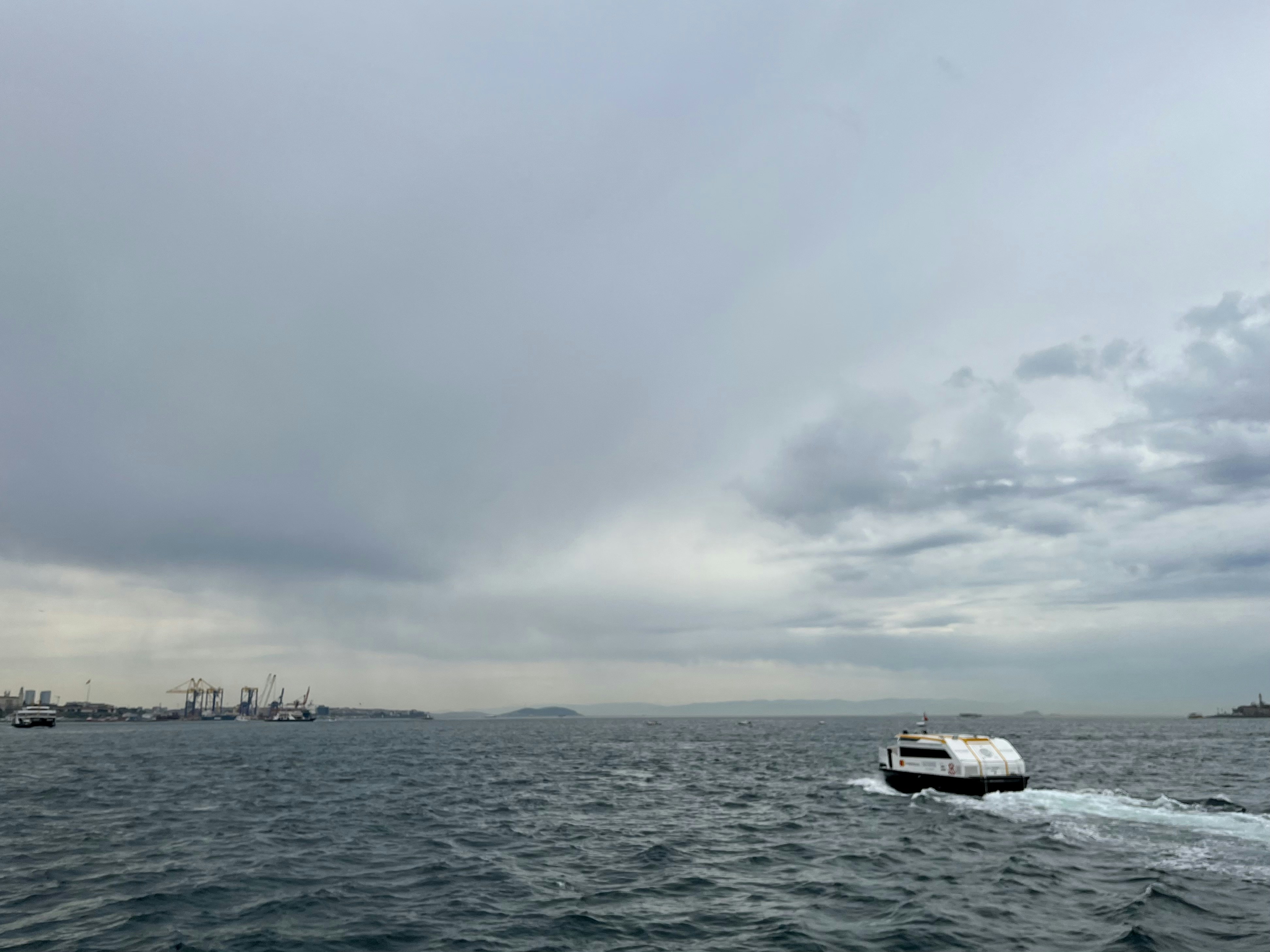 Horizon Runner: a white speedboat slices through a moody harbor