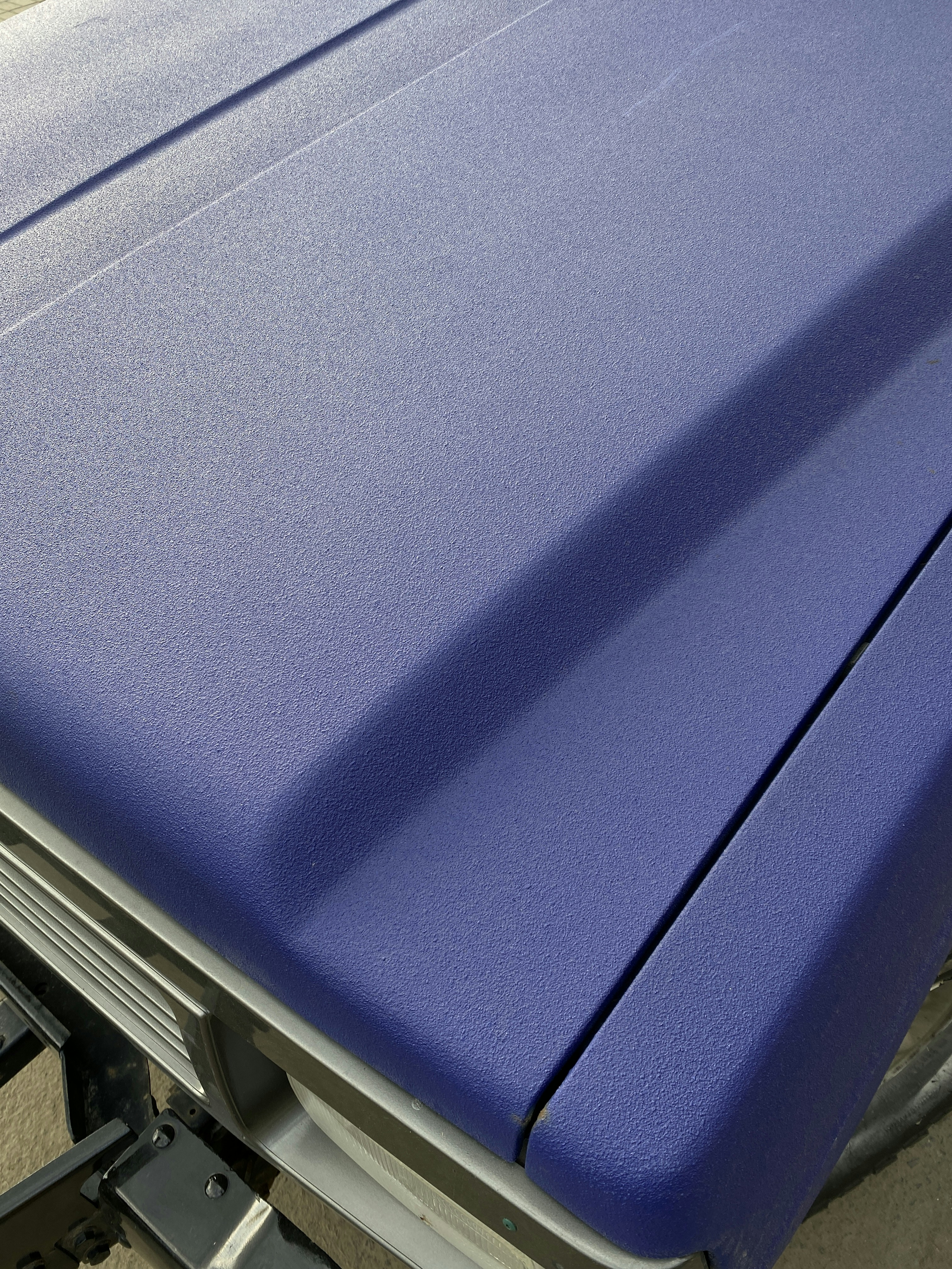 Blue hood with faint texture and chrome grille edges