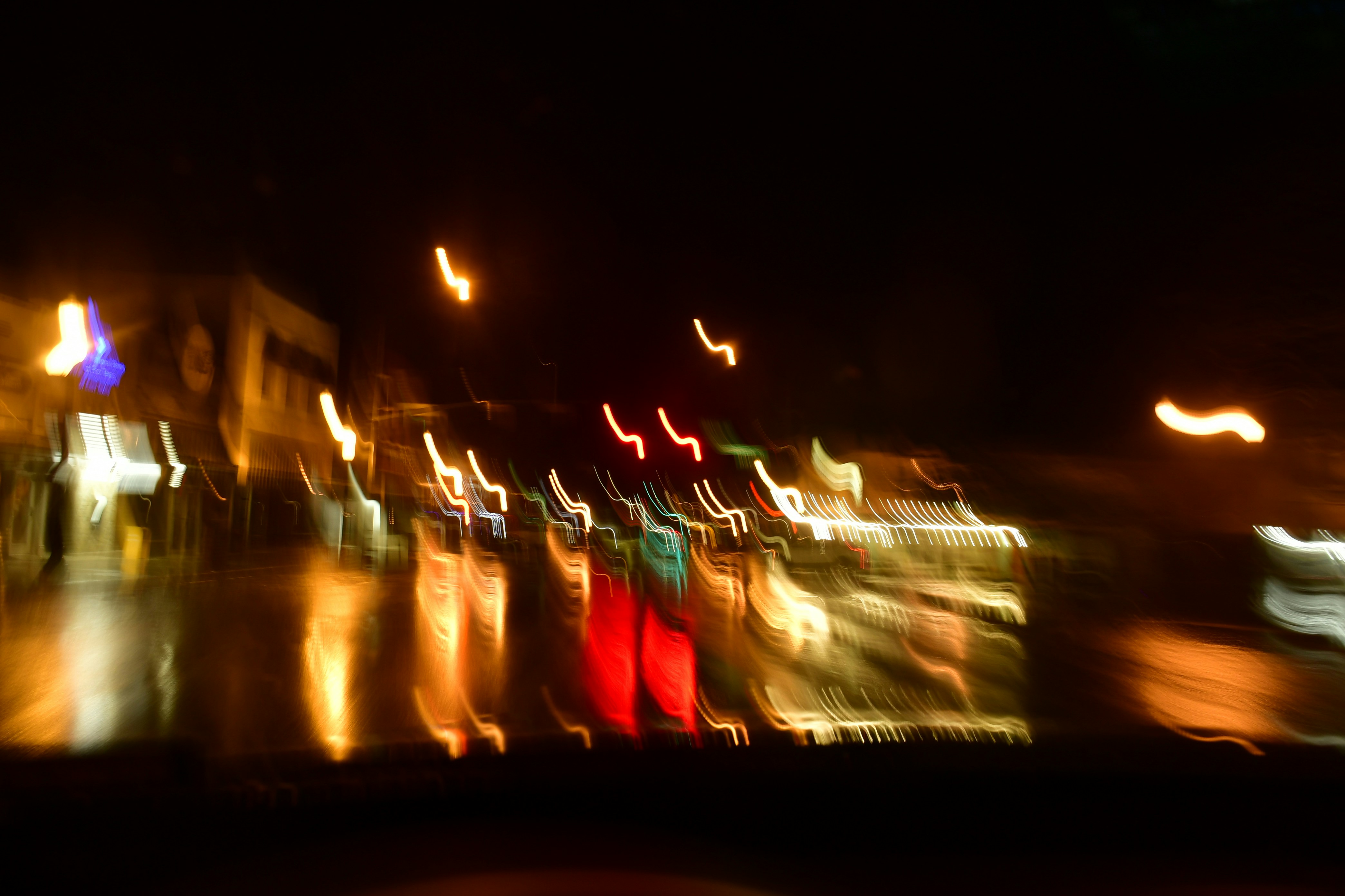 Red Center Glow: Neon Trails on a Rainy City Night