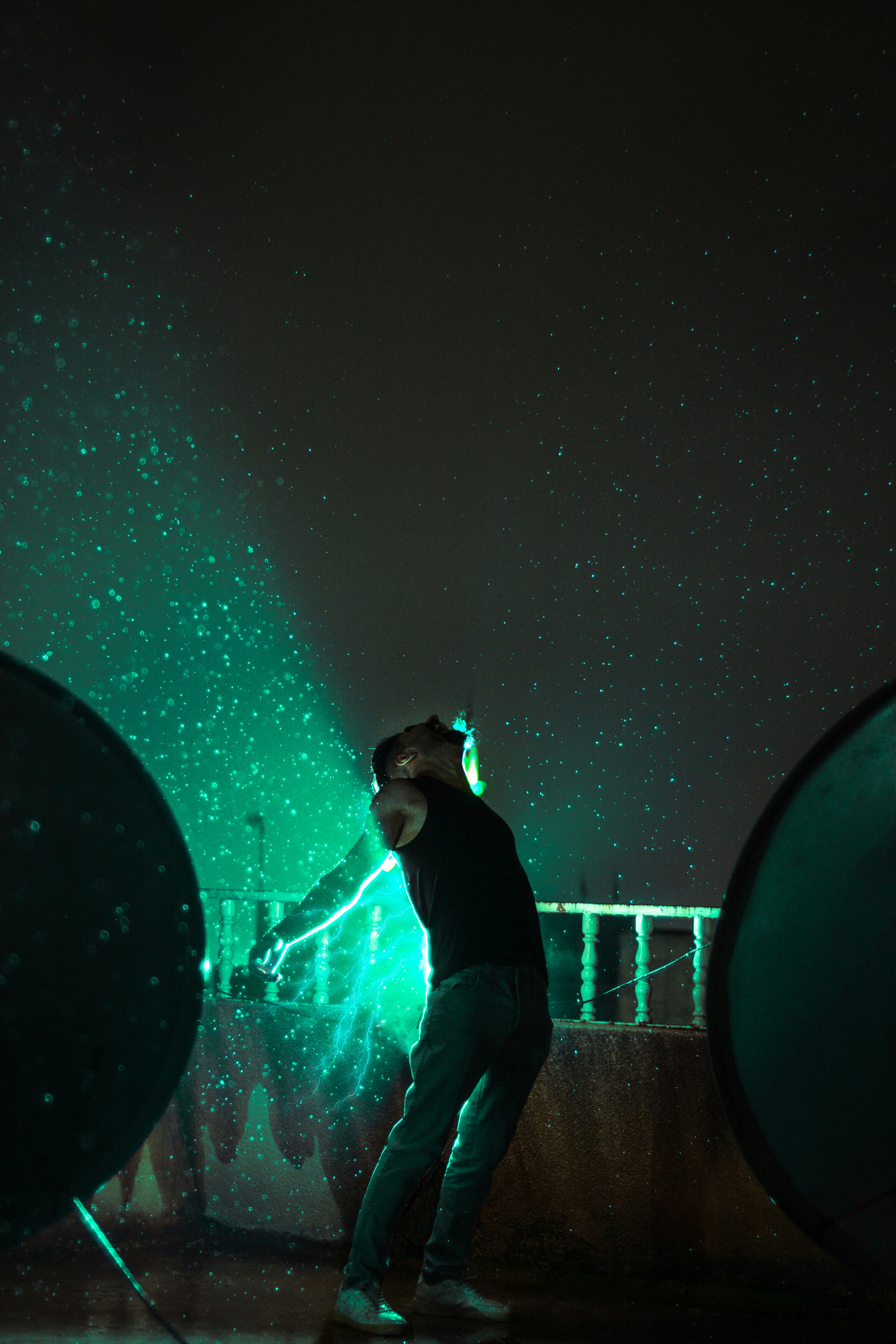 A man standing in front of a green light photo – Free Lighting Image on ...