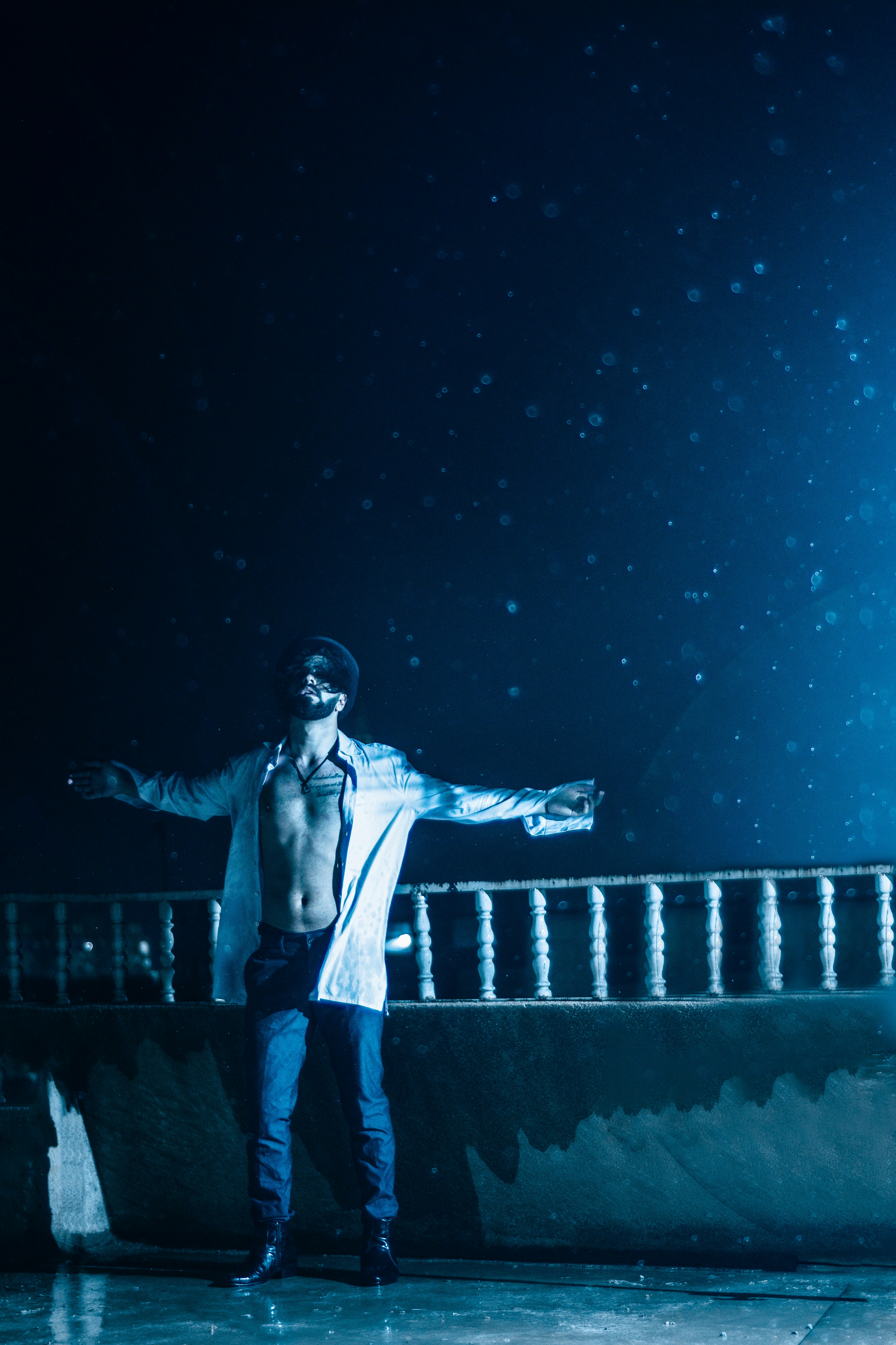Midnight Solitude: A Roaming Figure Beneath a Starfall Sky