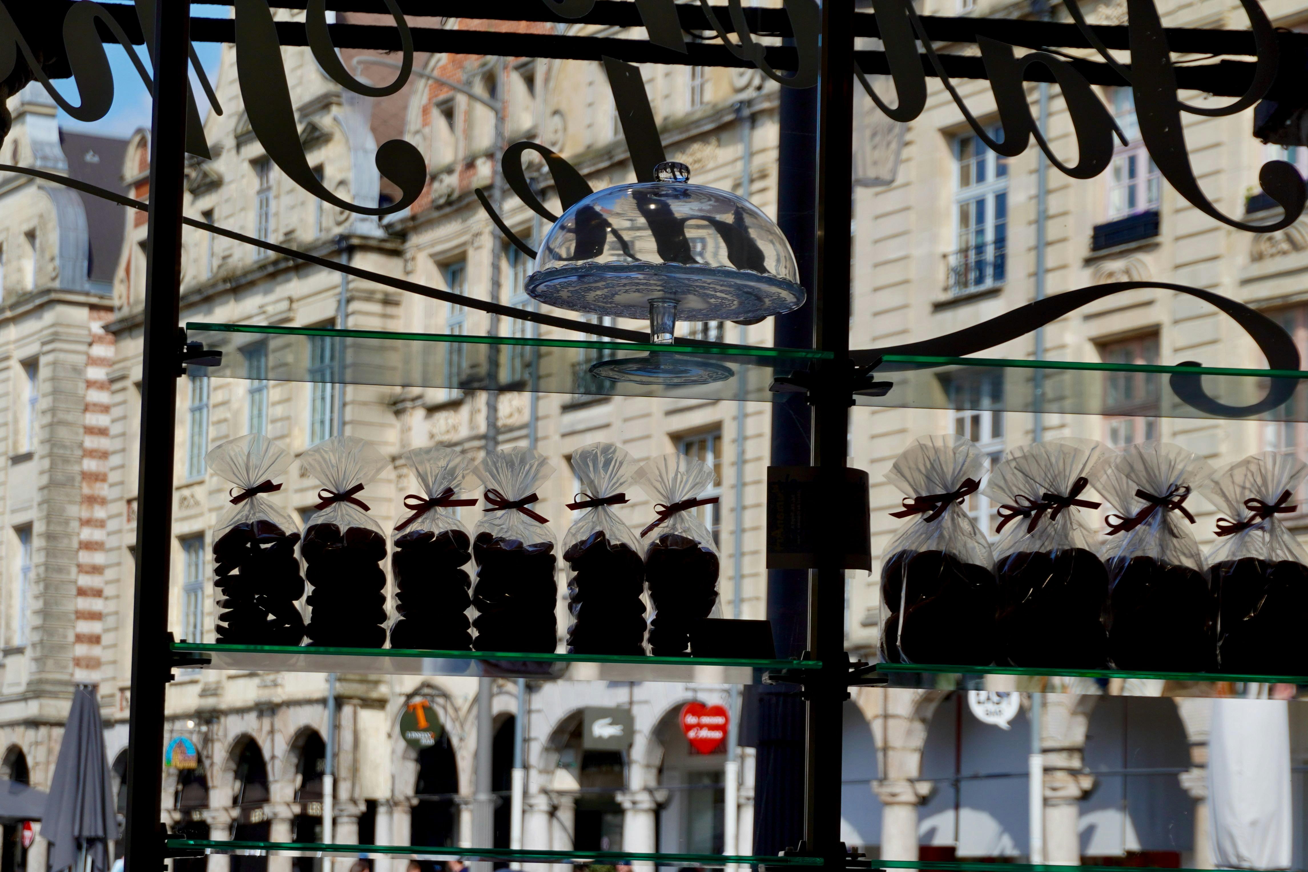 Arresting silhouettes behind a glass storefront in an urban arcade