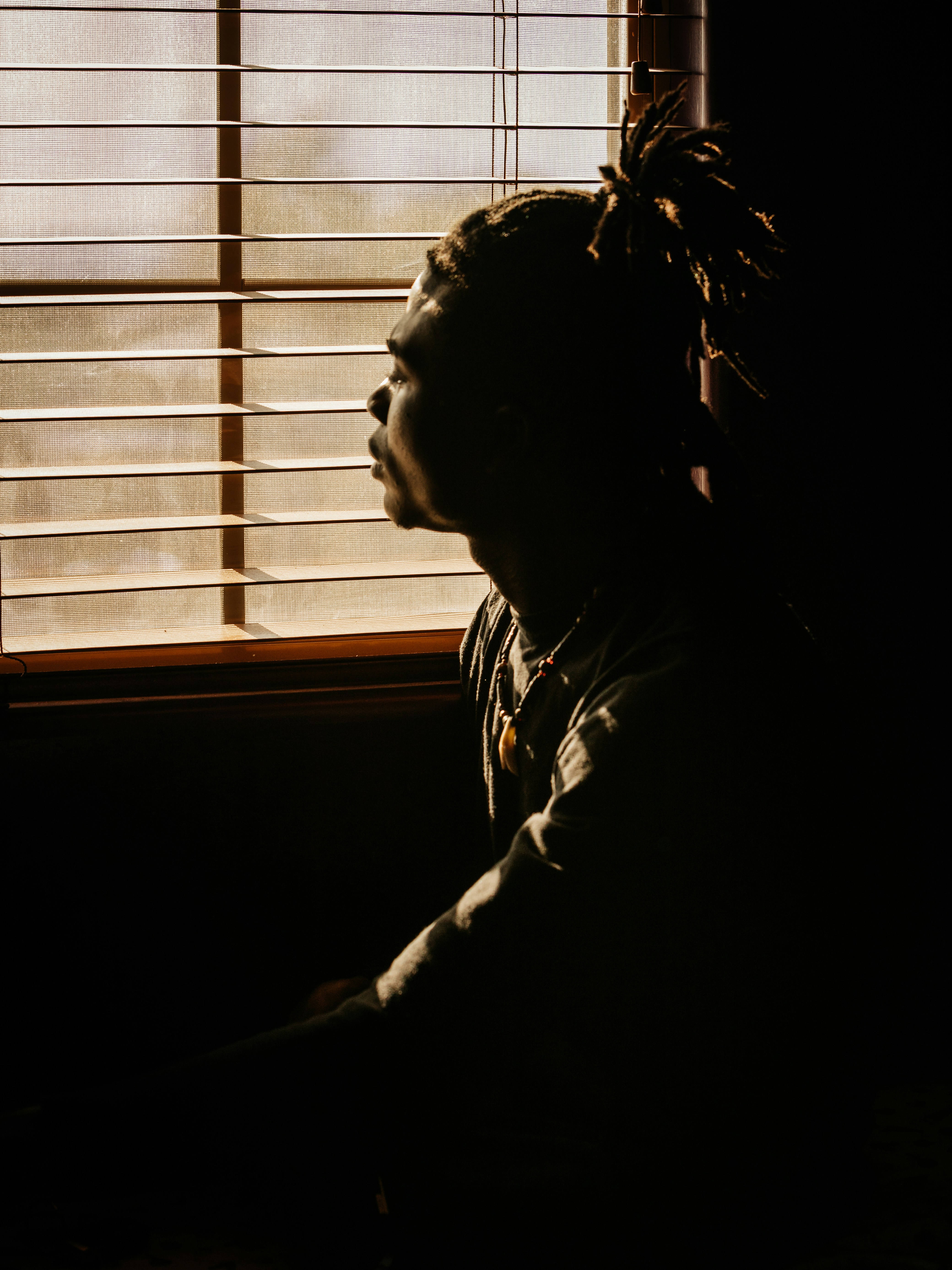 Backlit Stillness: Profile Silhouette by Window Light