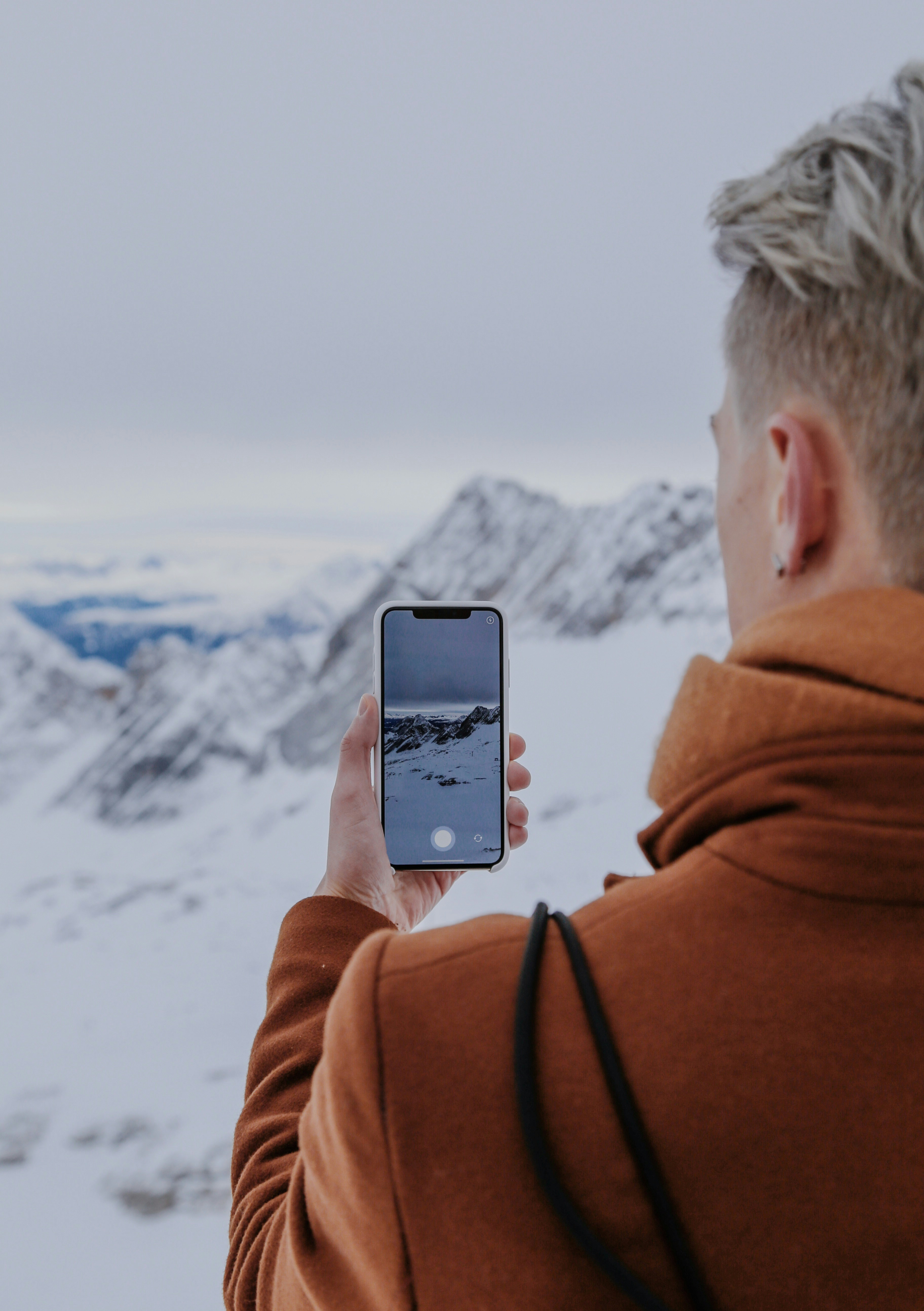 Glacier Gaze: Framing Winter Peaks Through a Phone in a Rust Coat