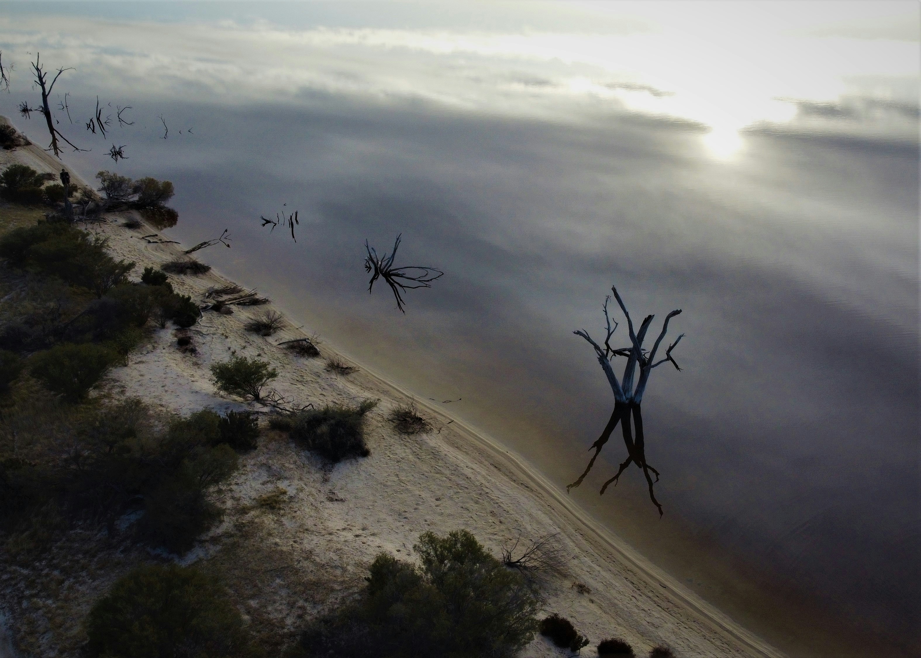A body of water surrounded by land and trees photo – Free Western ...