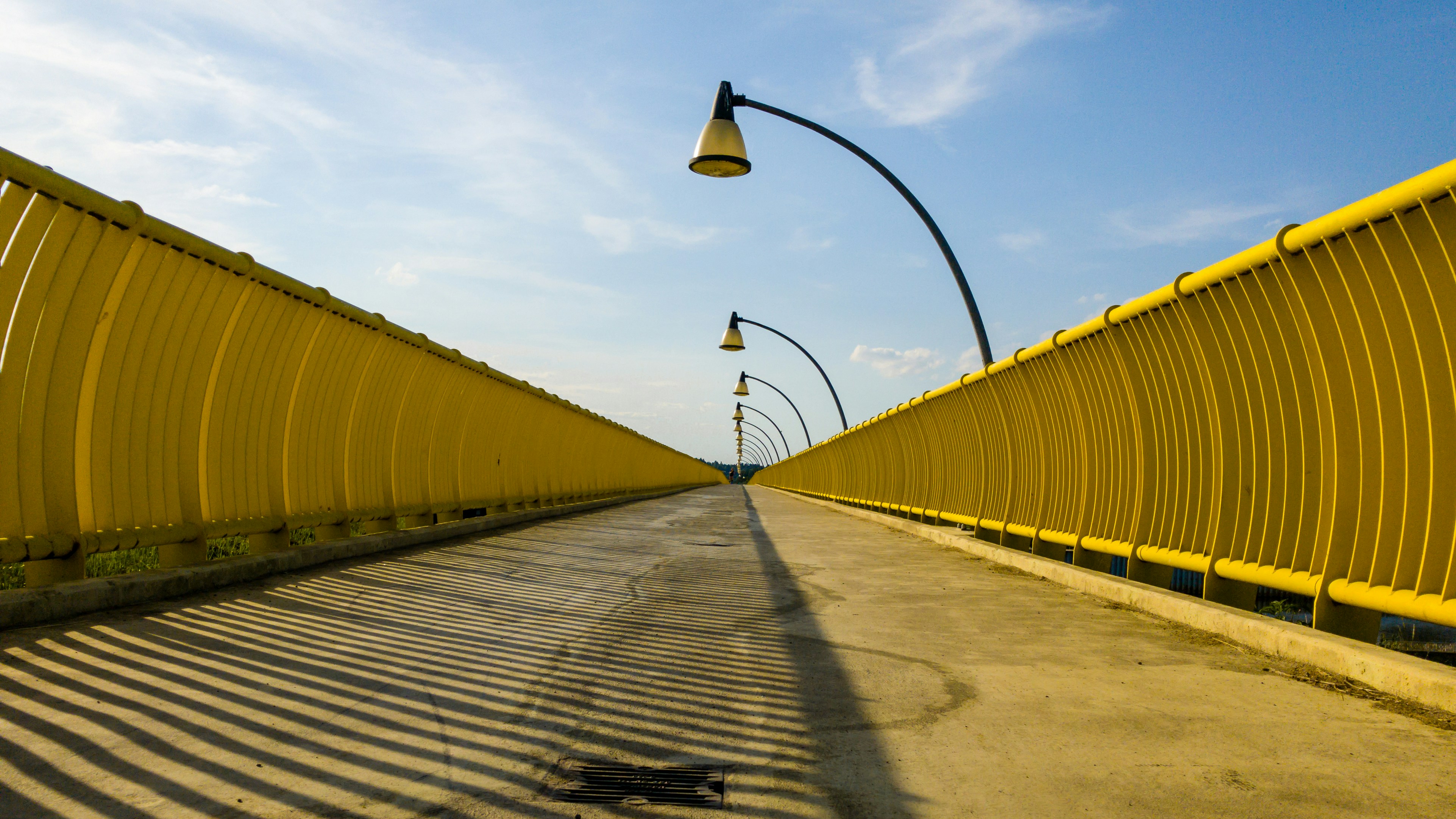 Vanishing Point on a Sunlit Yellow Bridge