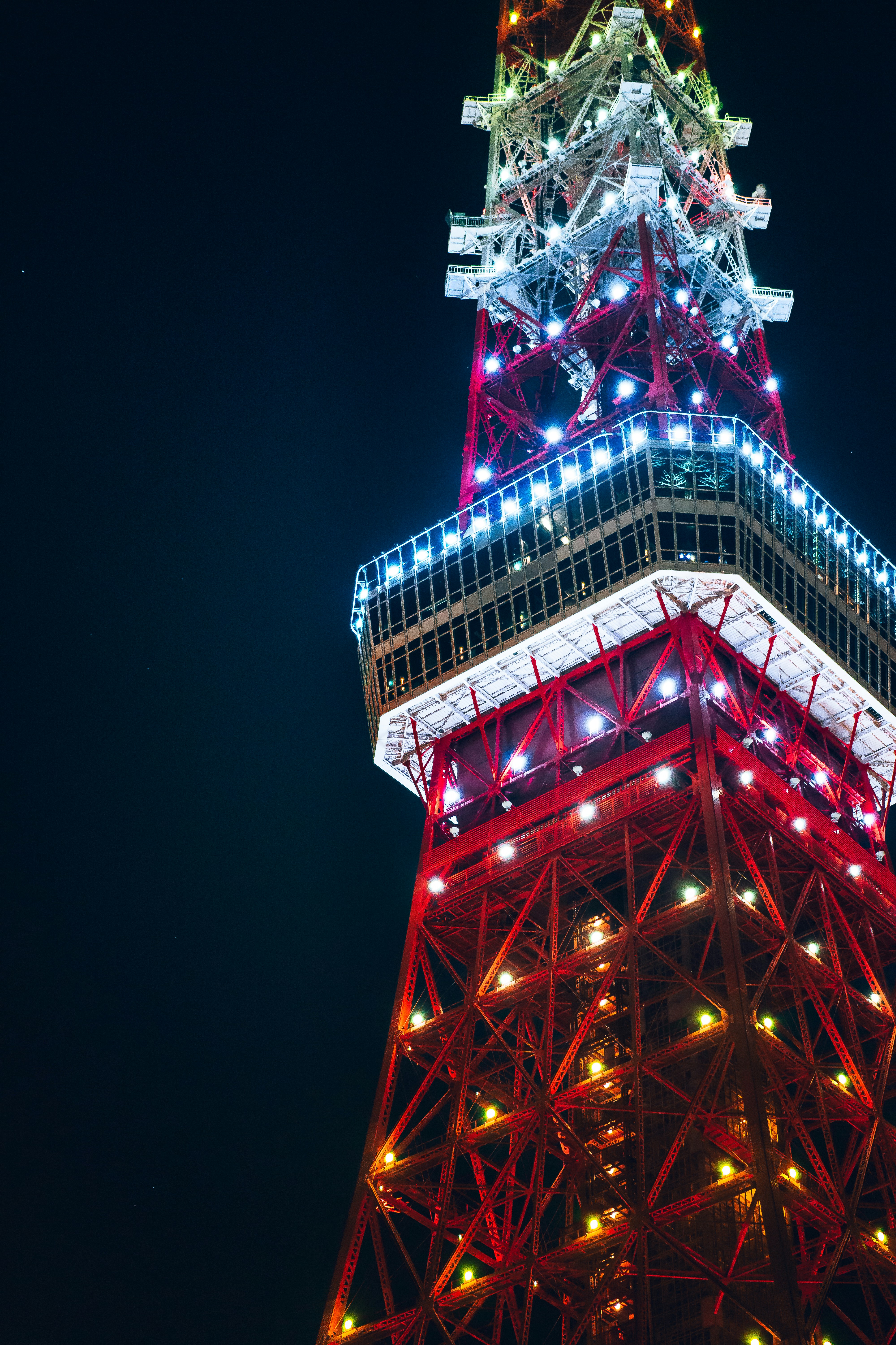 Prismatic Lattice at Night: Neon-lit Red Tower Soars Against the Dark