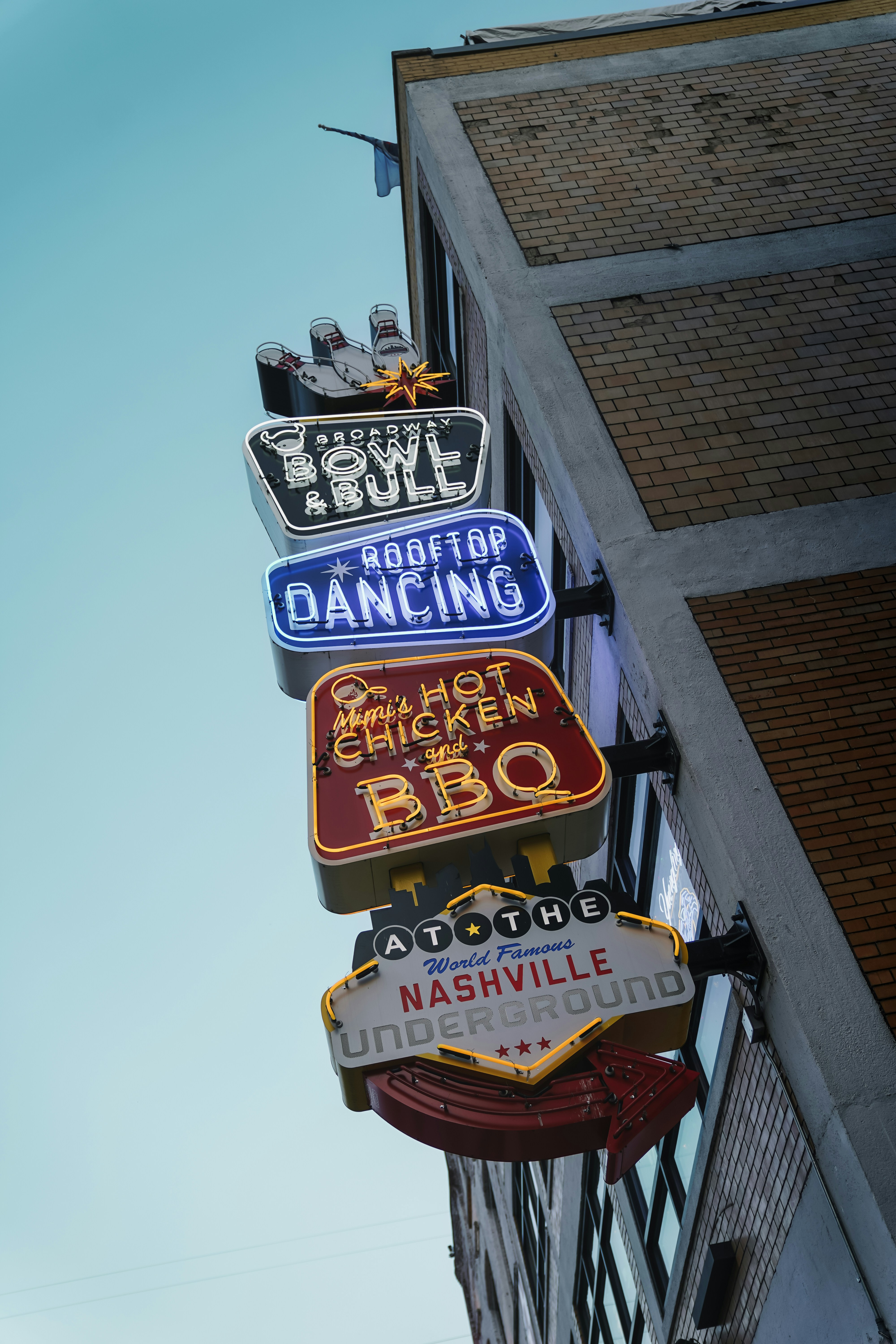 Neon Sign Cascade Over a Nashville Brick Facade