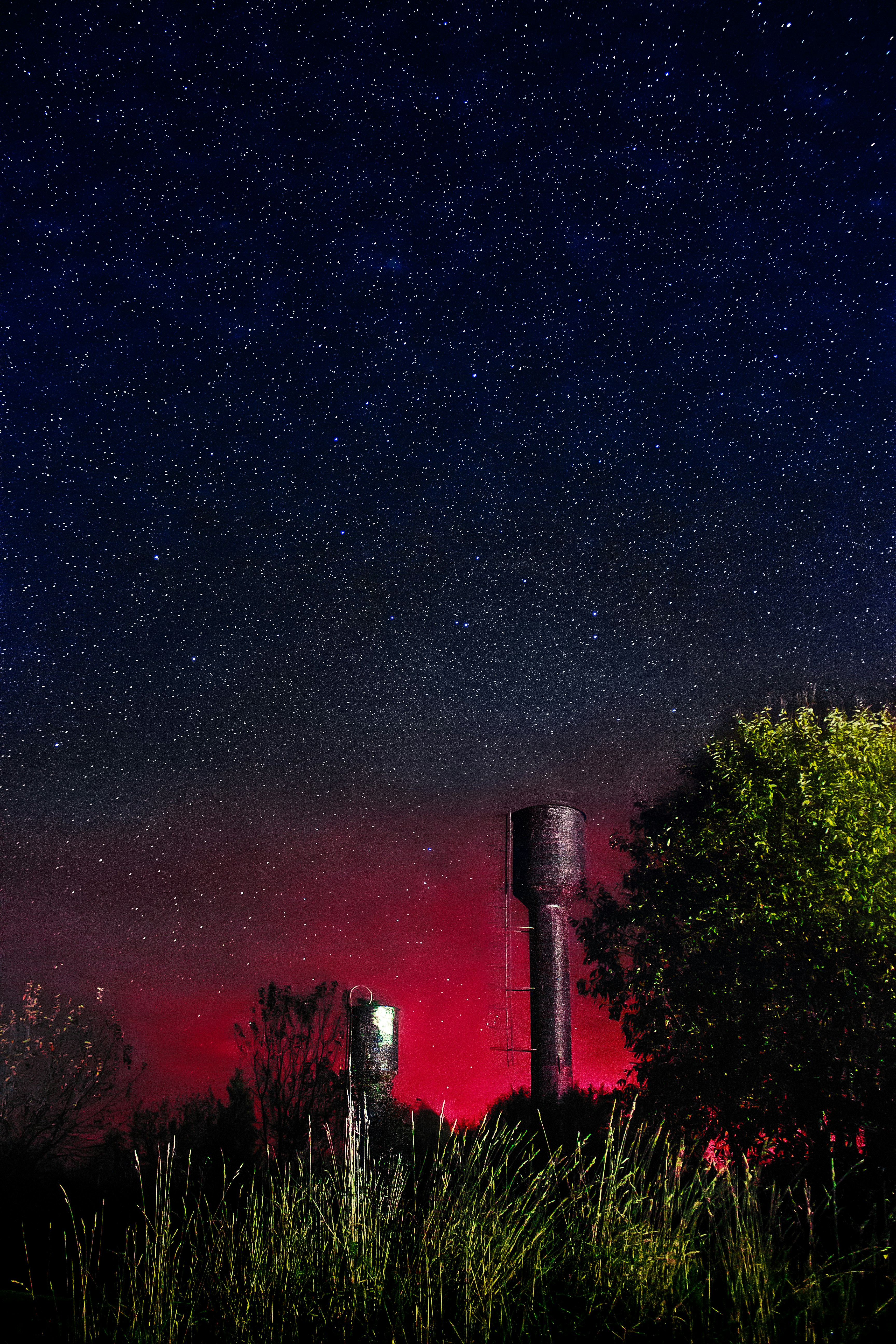 Stars Over the Water Tower: a Red Horizon Beneath Velvet Night