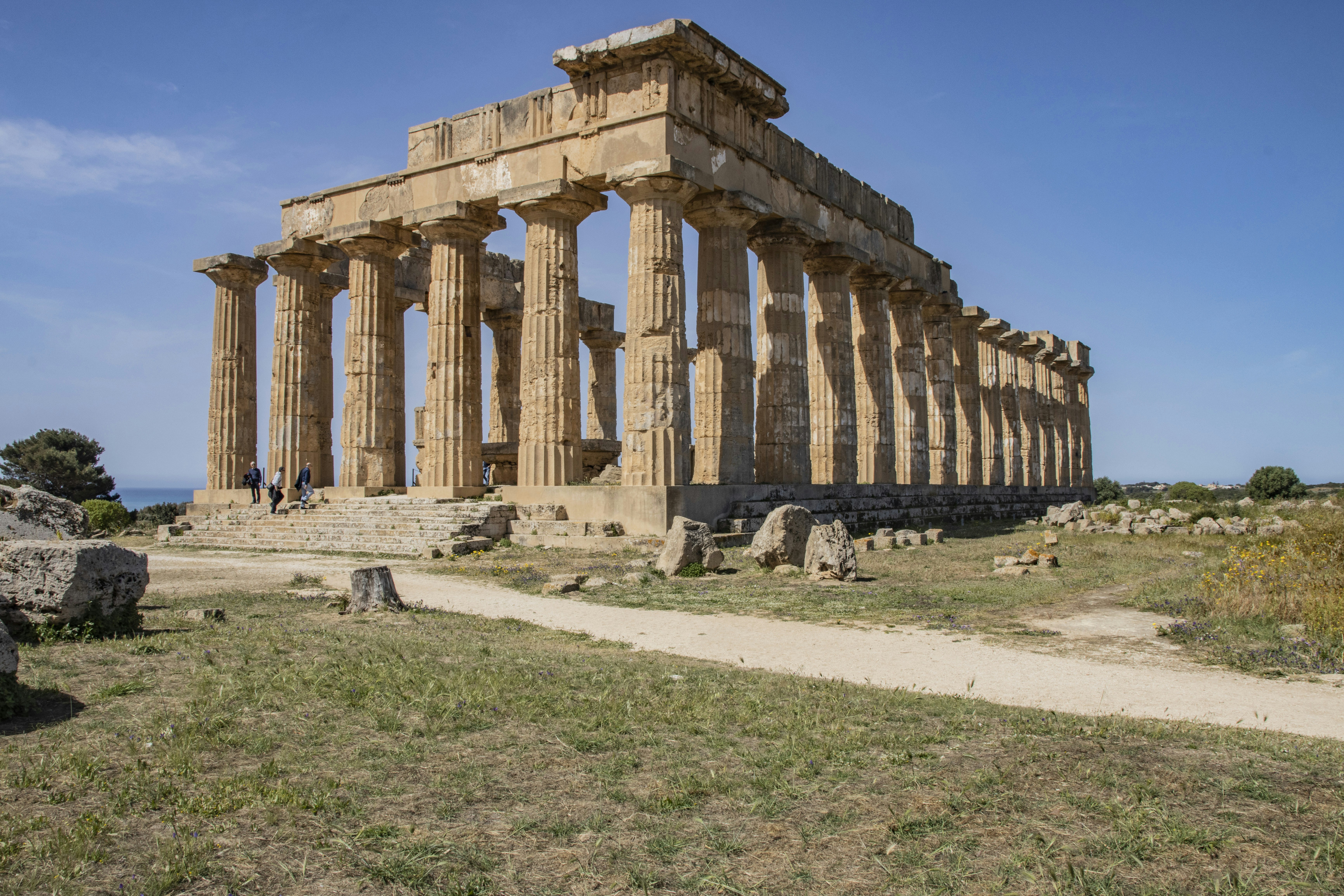 A large stone structure sitting on top of a lush green field photo ...