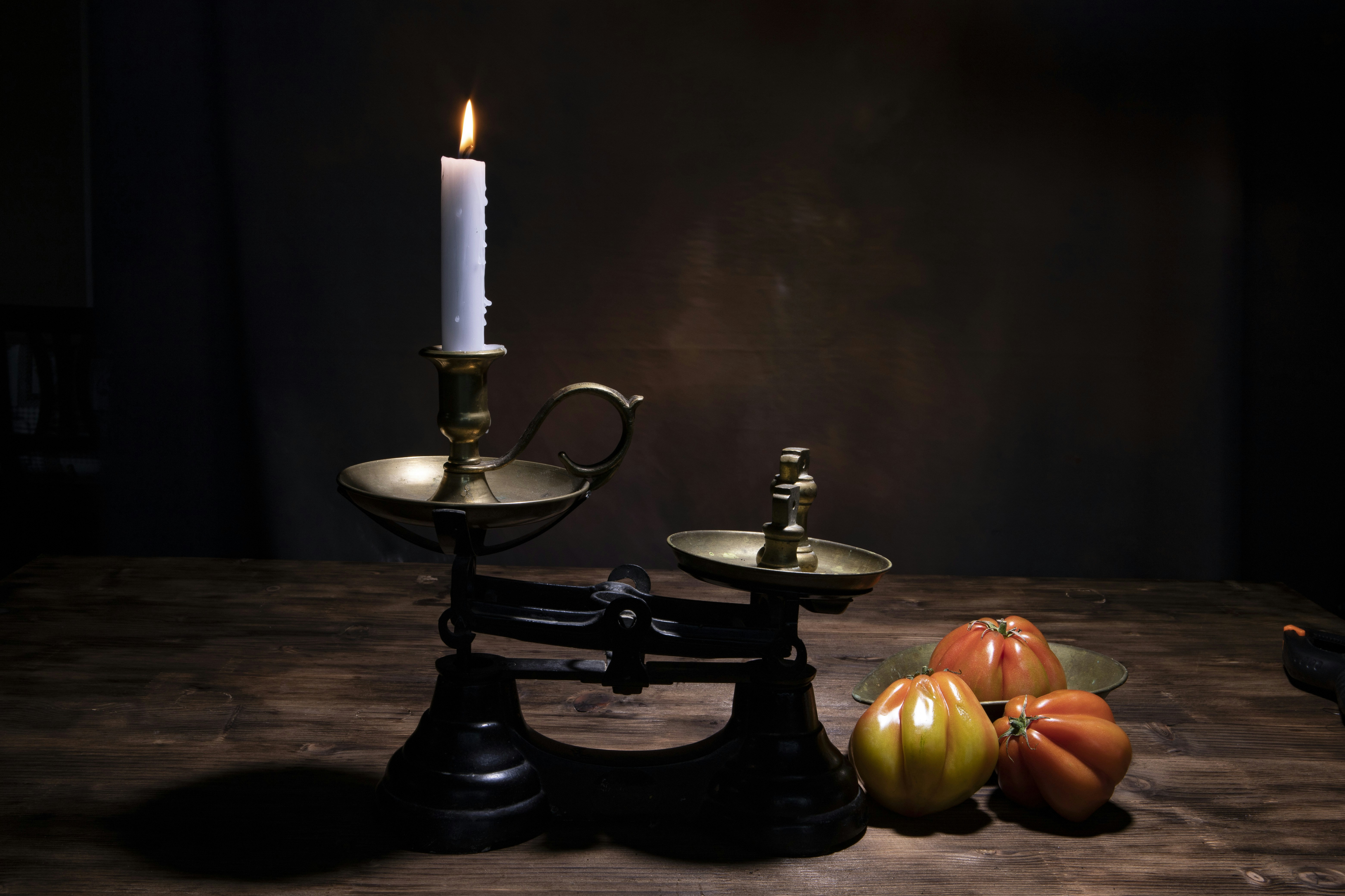 Candlelight Balance: A Quiet Still-Life with Scales and Tomatoes