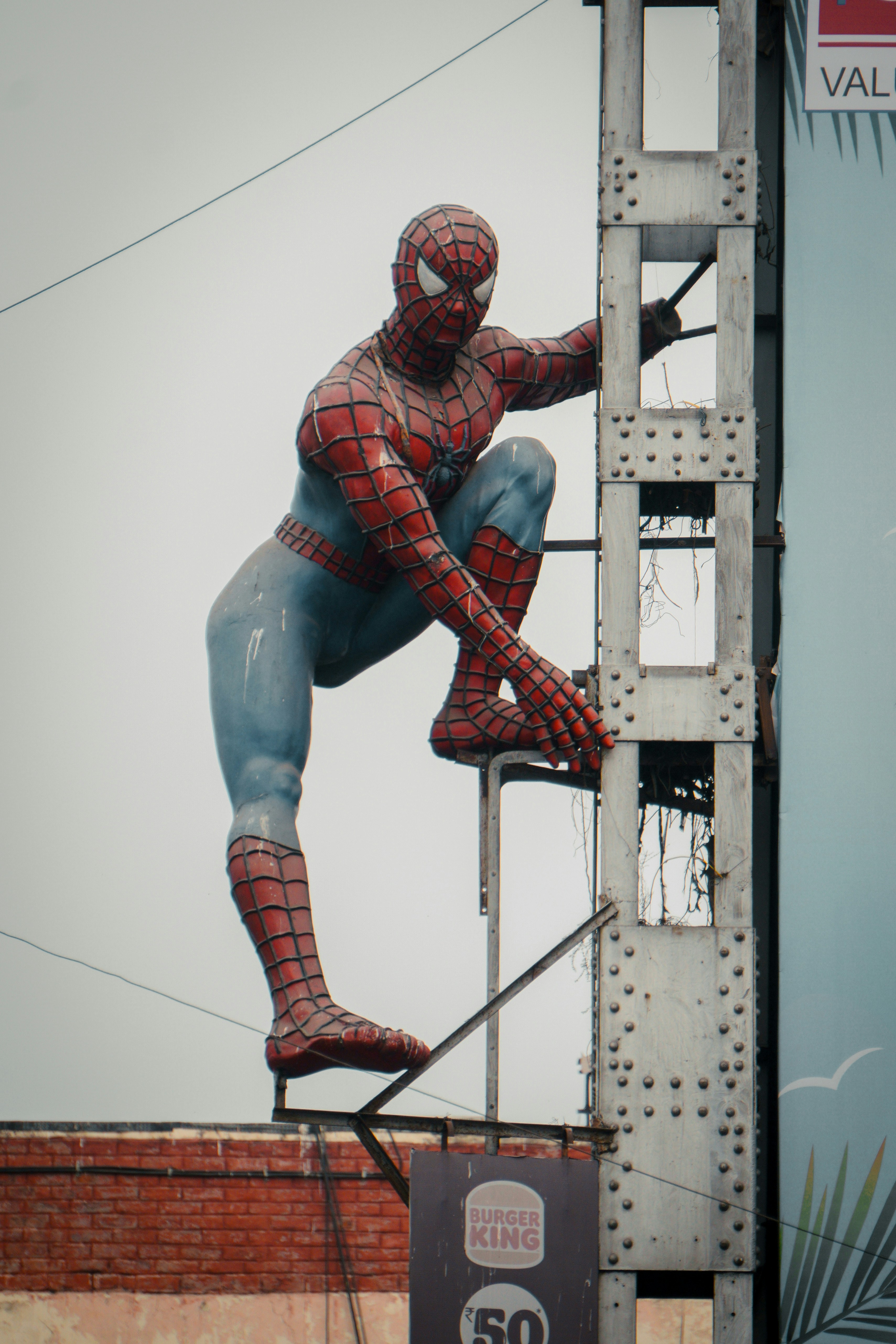 A statue of a spider man on top of a building photo – Free Kolkata ...