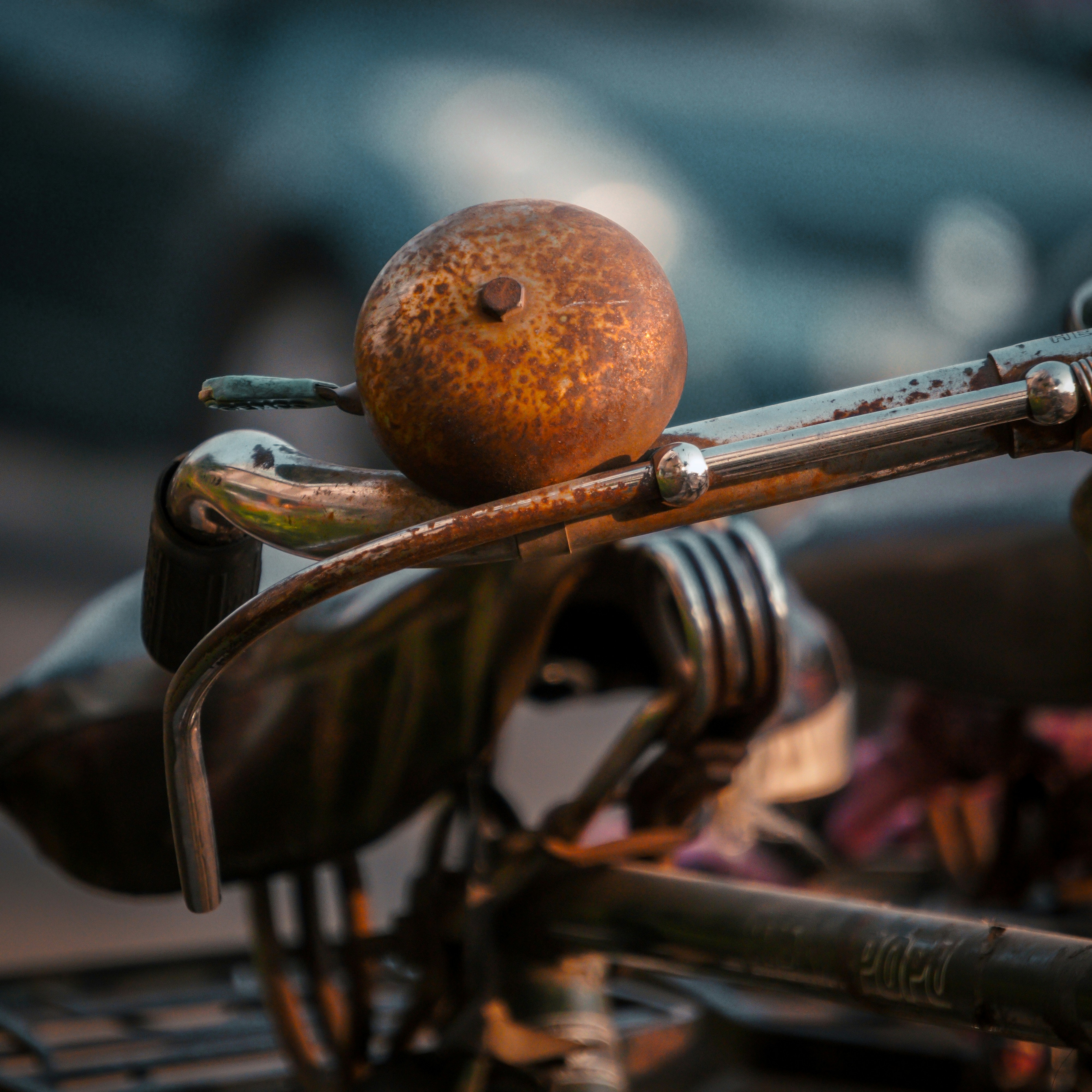 Rust-Burnished Bell on a Weathered Handlebar: A Quiet Portrait of Time