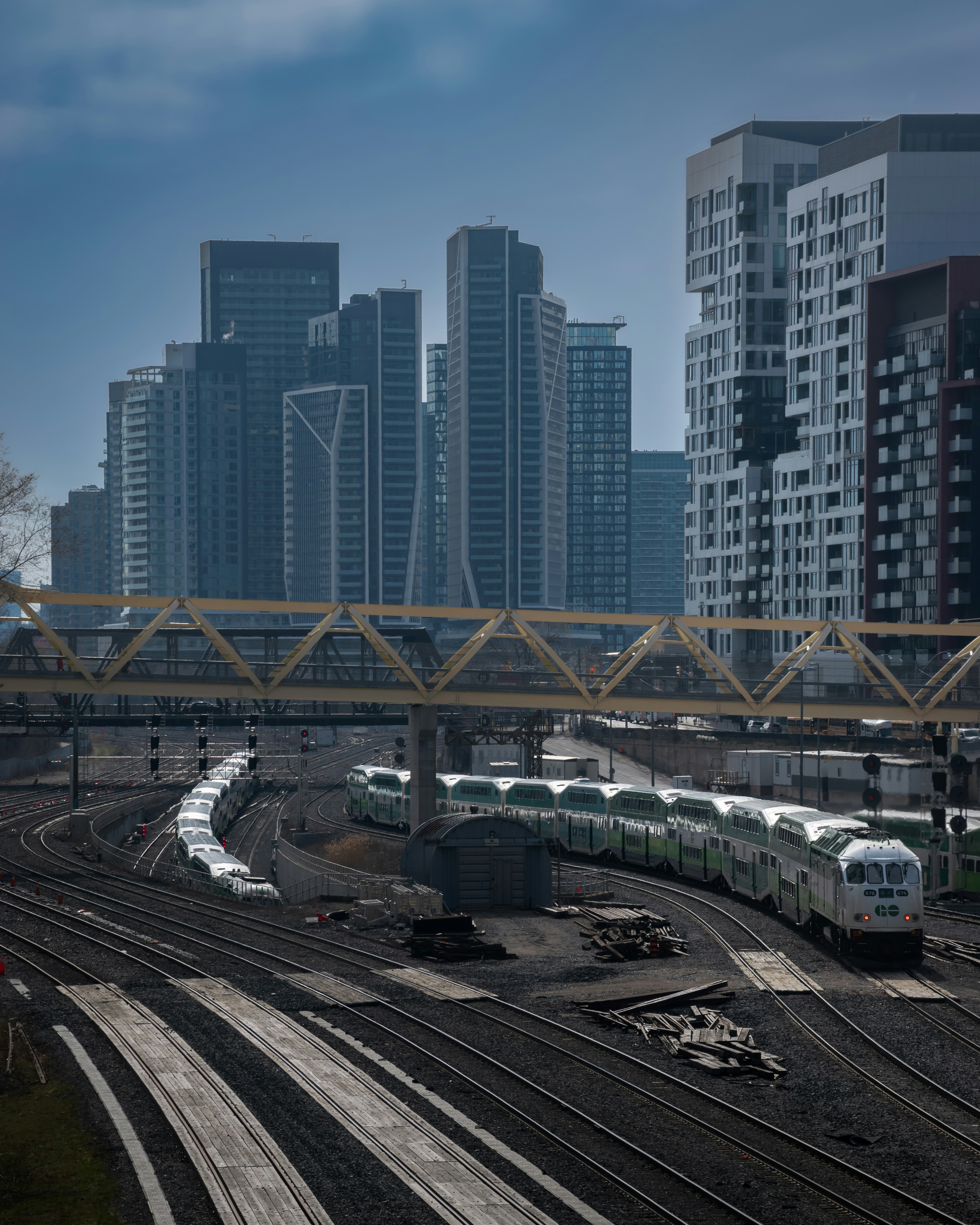 Yellow Bridge Over Rails: A Cityscape Framed by Towers