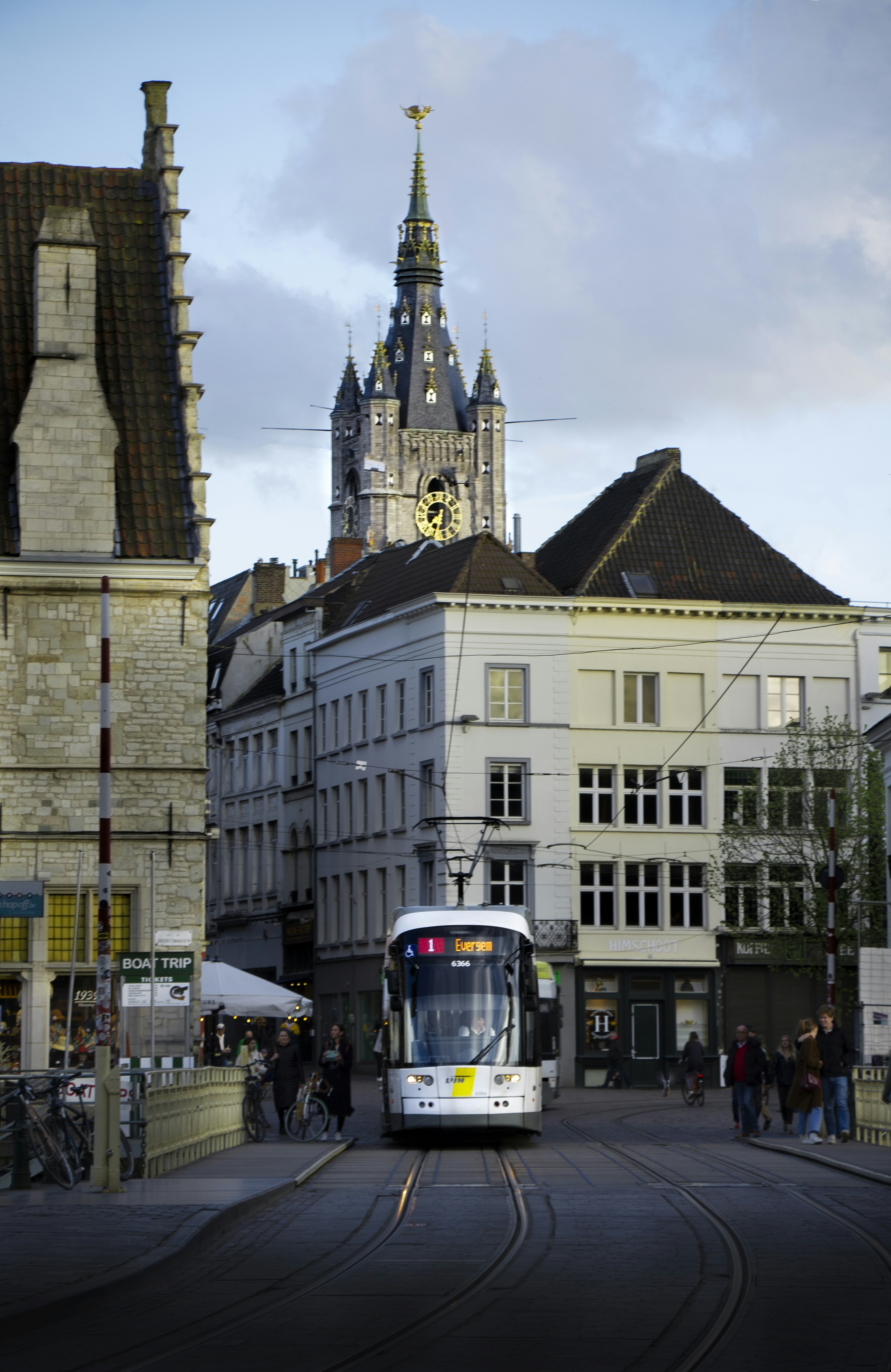 Tram Tracks and a Gothic Belfry: City Light on a Narrow Street