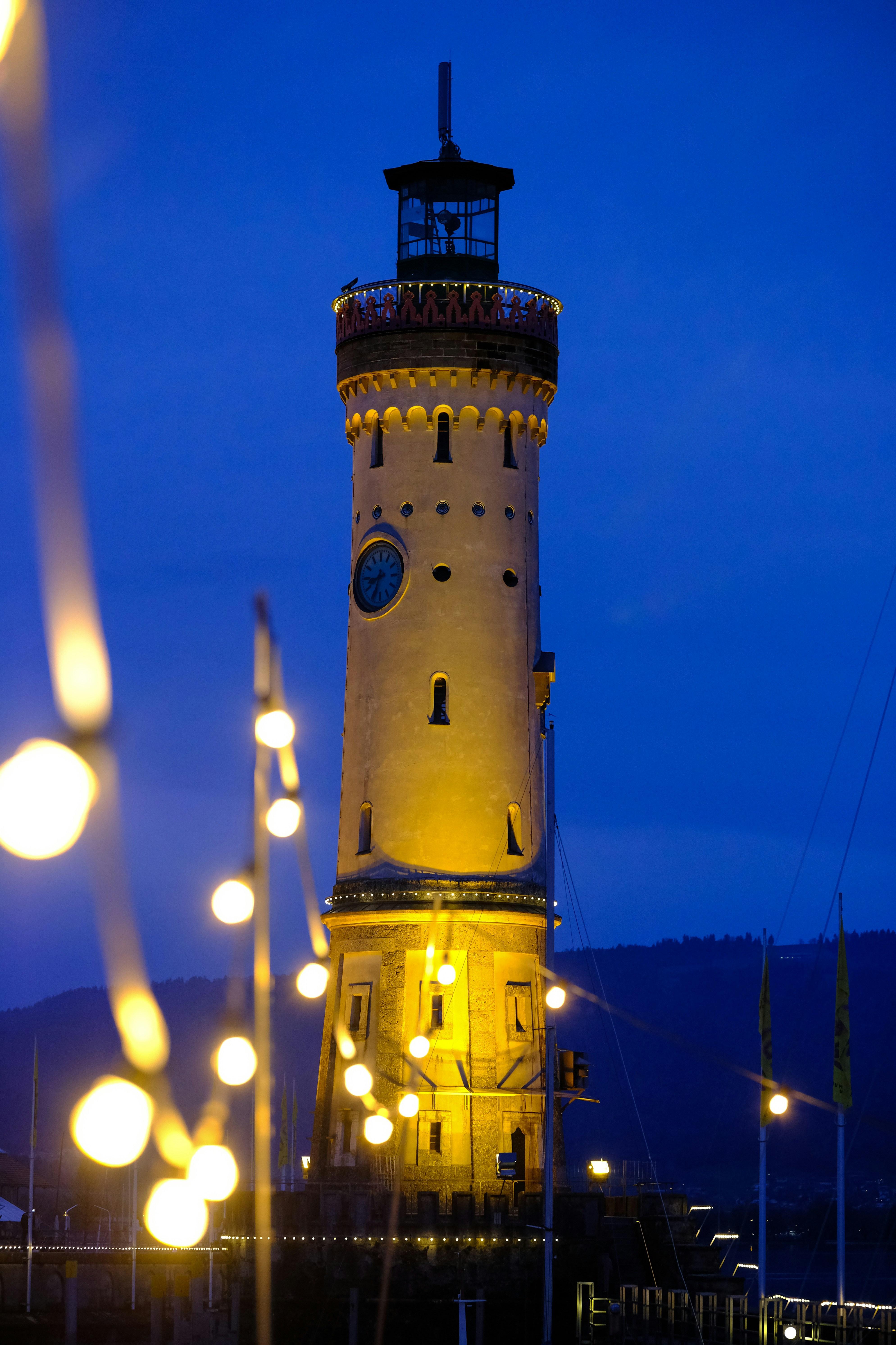 Blue Hour Beacon: The Lantern Tower Rising Over a Bokeh-Filled Pier