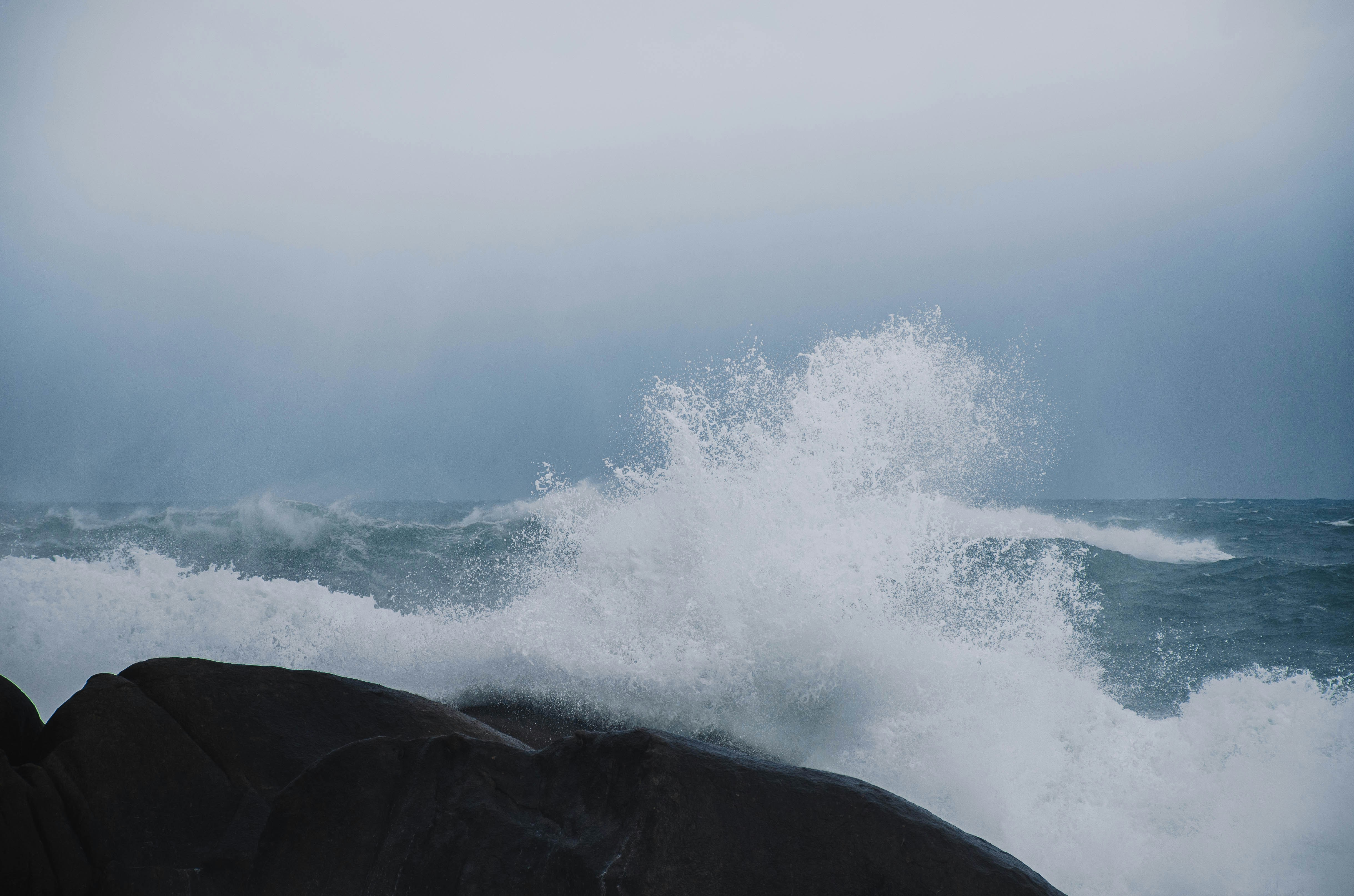 A large wave crashing over a large rock photo – Free Cam ranh Image on ...