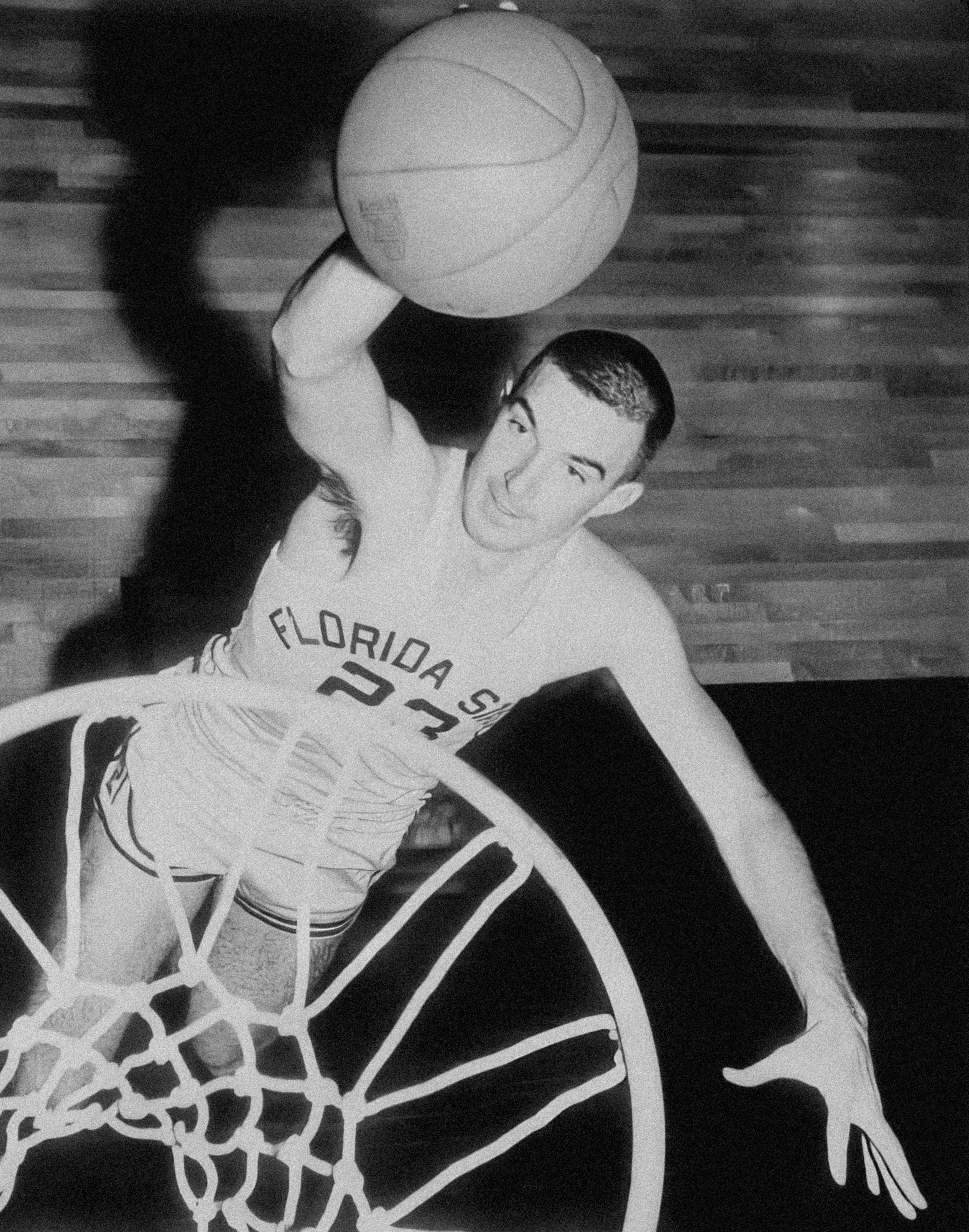 A man is dunking a basketball into a hoop photo – Free Vintage ...