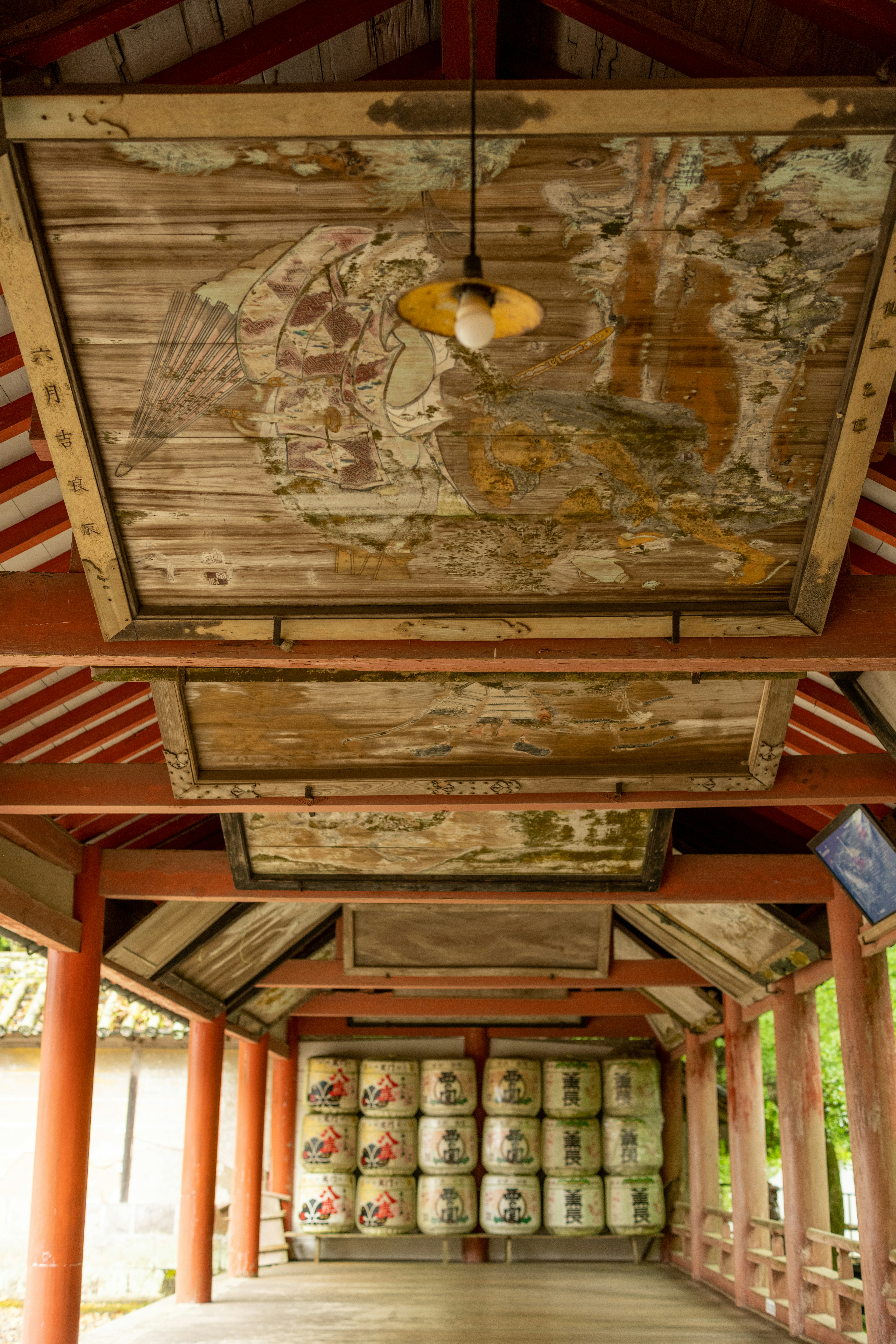Aged Ceiling Fresco Over a Row of Sake Barrels in a Temple Corridor