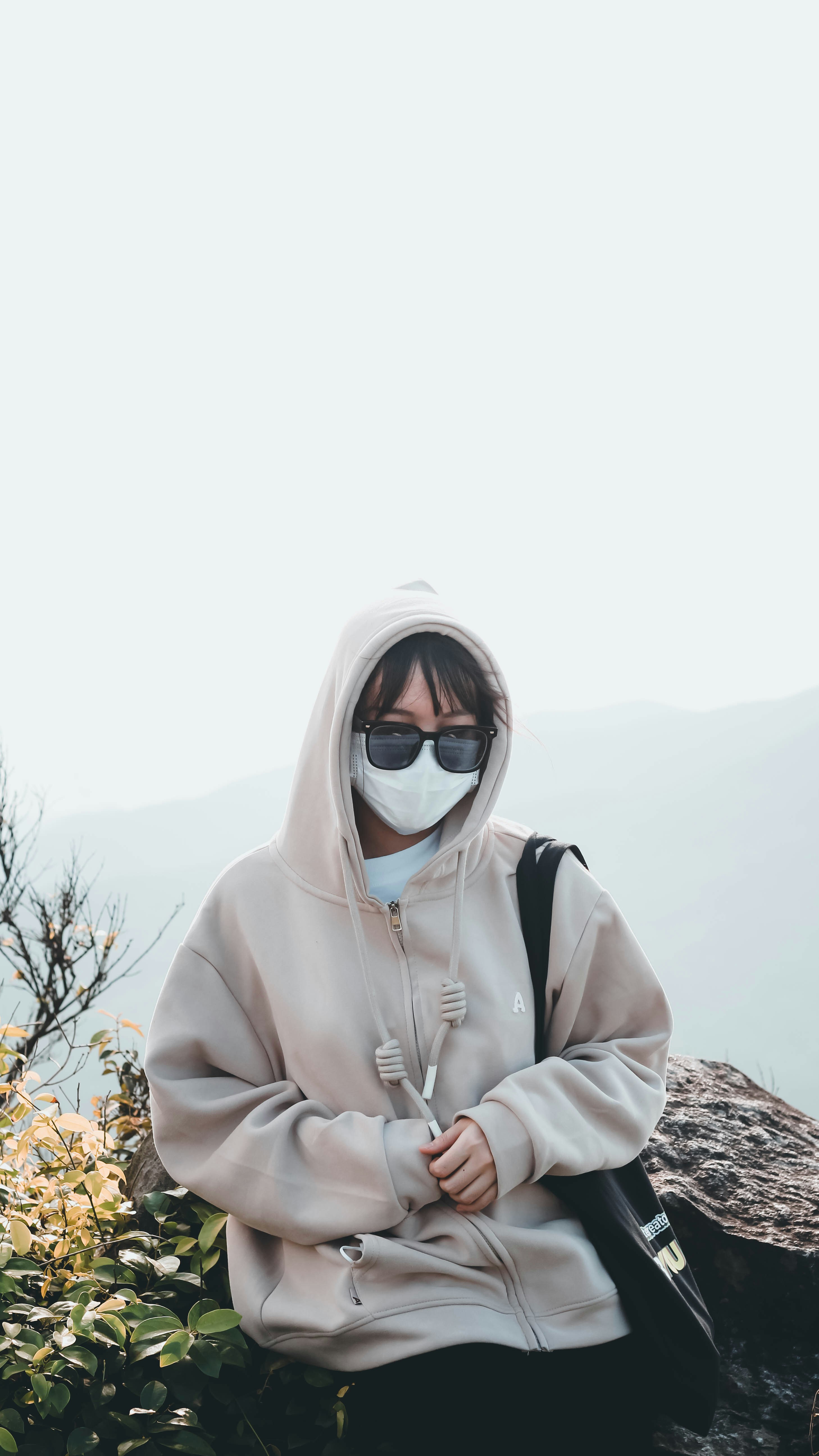 A person sitting on a rock wearing a mask photo – Free Sơn trà Image on ...
