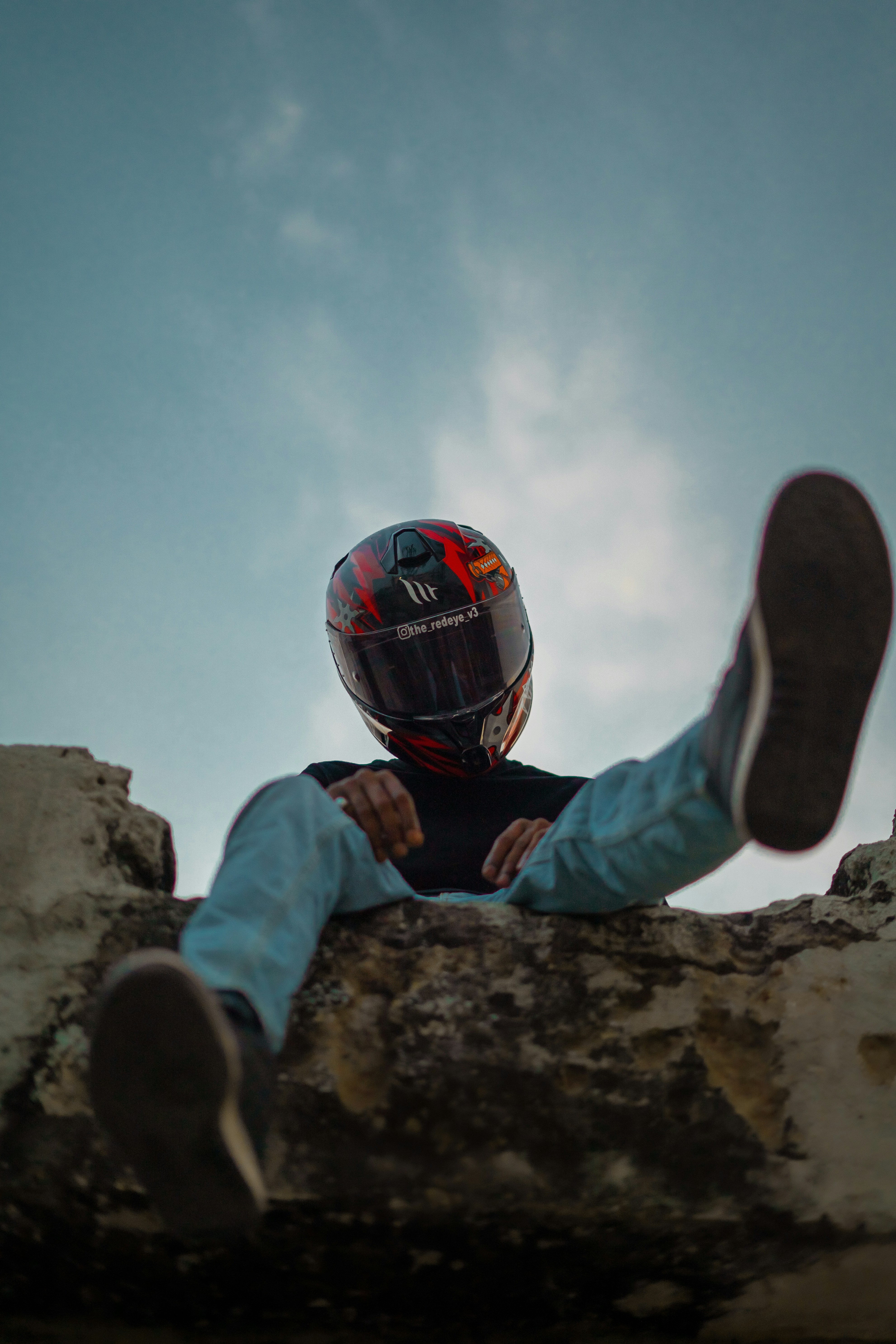 Over the Edge: Helmeted Grin Above the Crumbling Rim