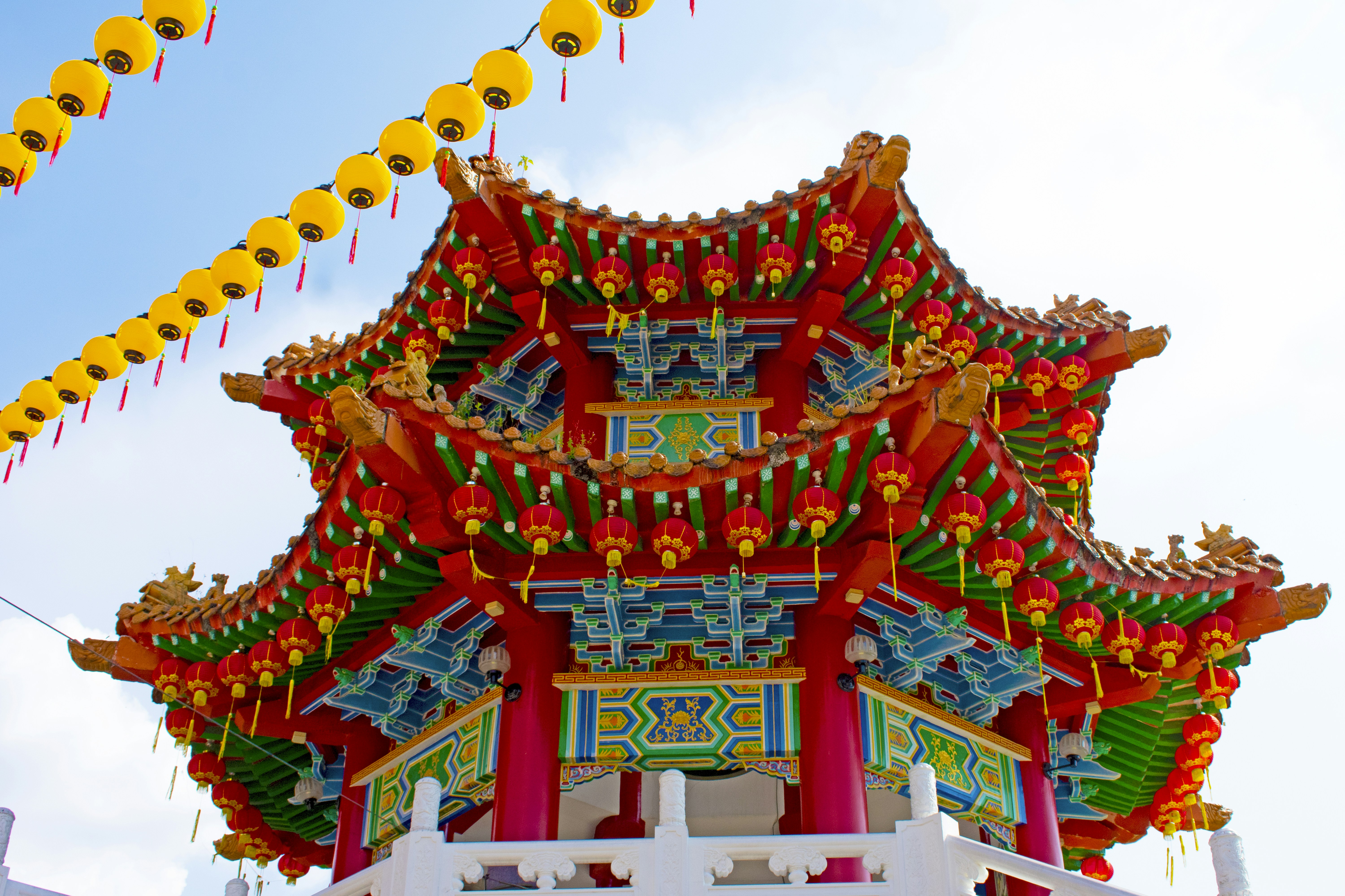 A chinese building with decorations hanging from it's roof photo – Free ...