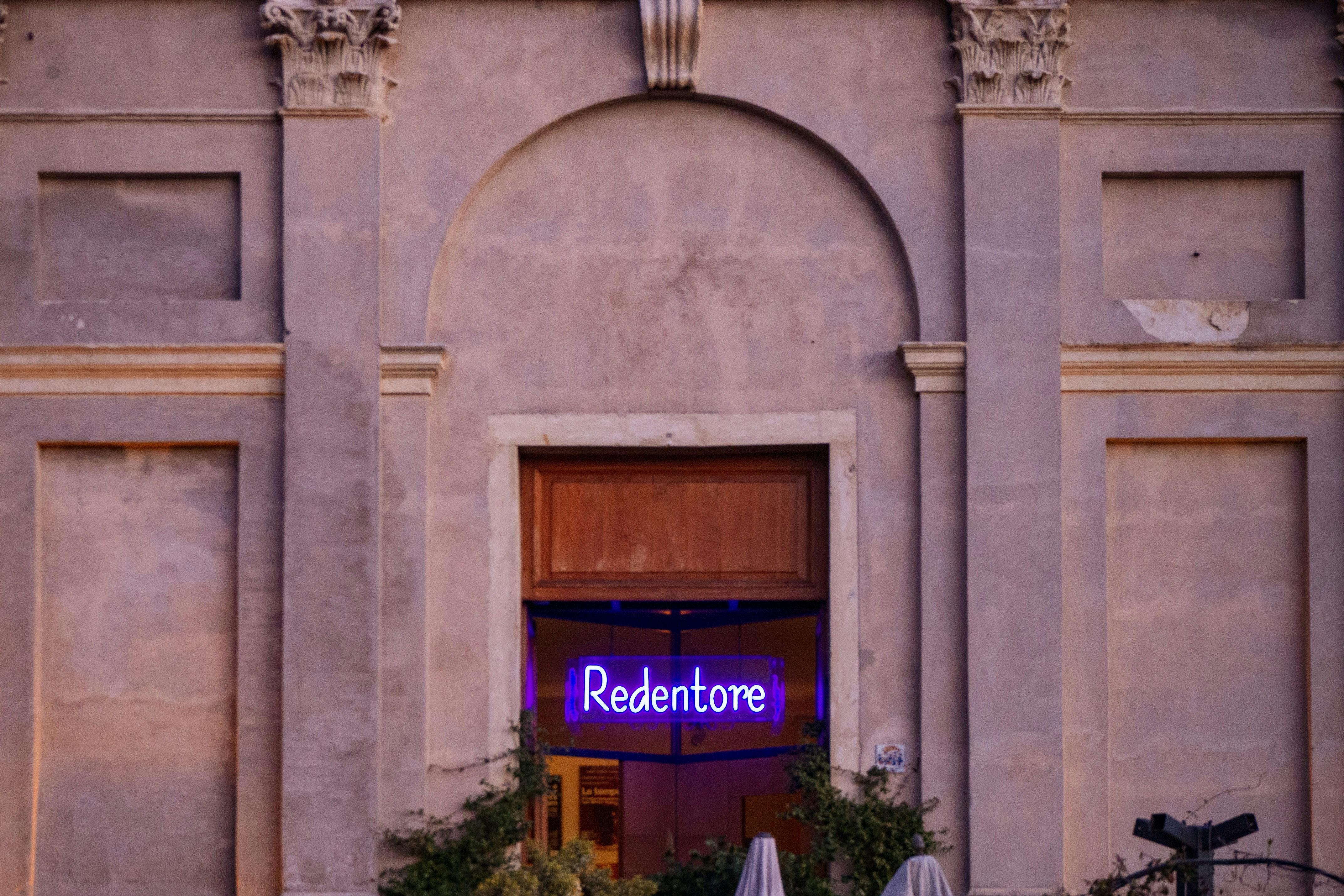 Blue Neon Through a Classical Archway: Redentore at Dusk