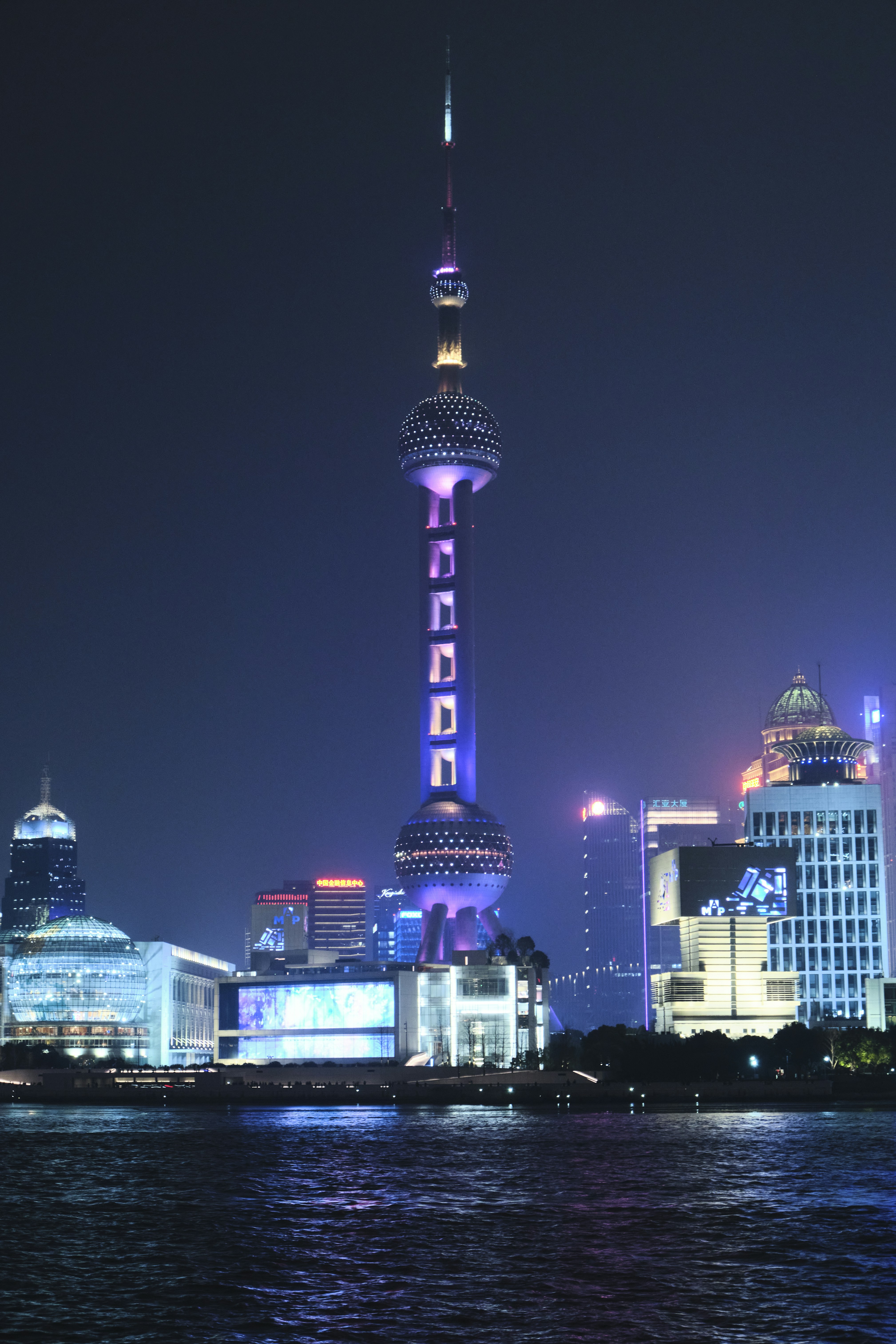 The oriental city skyline is lit up at night photo – Free China Image on Unsplash