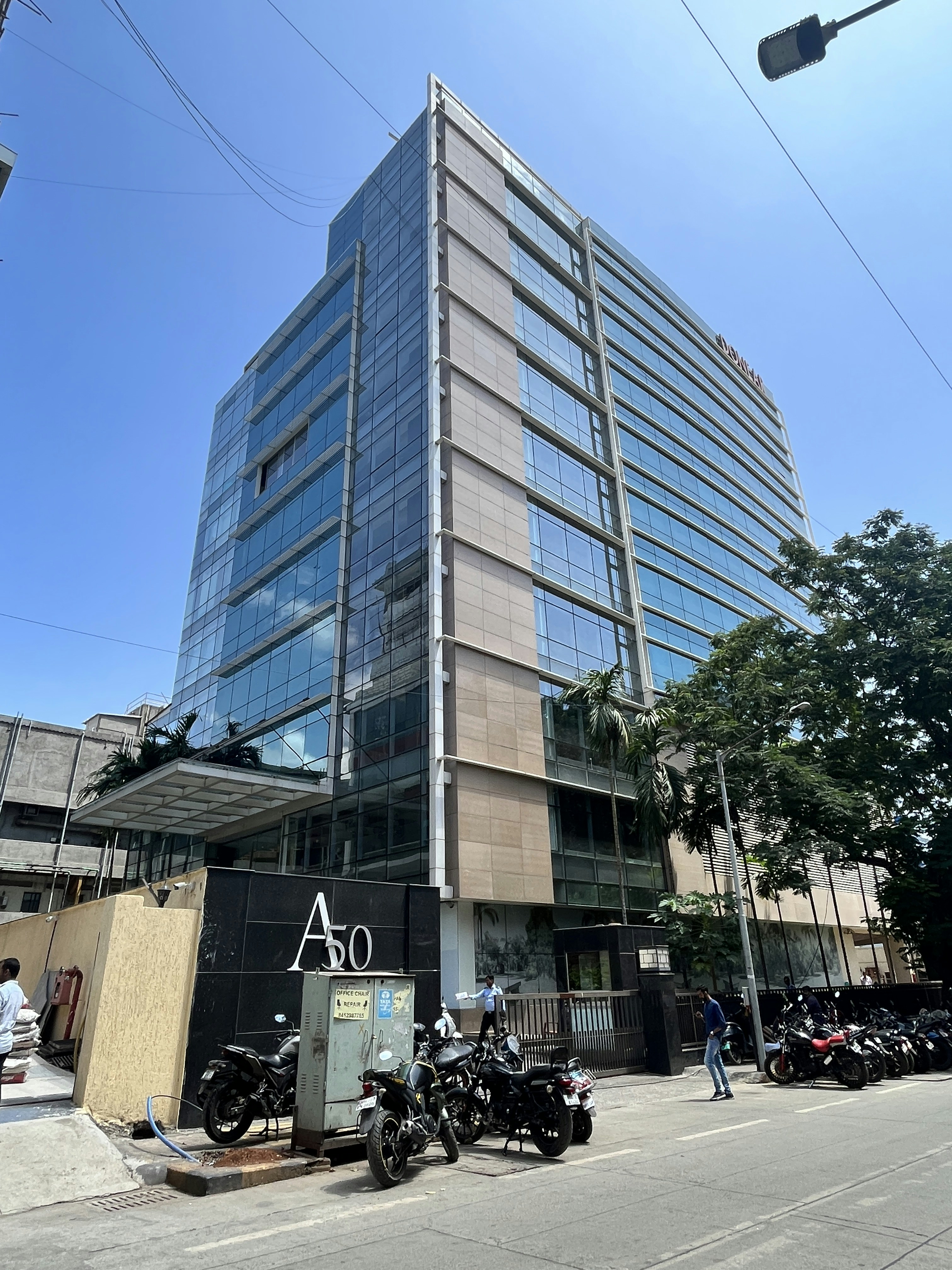 Azure Facade Rising: A Glass-Tower Over a City Street