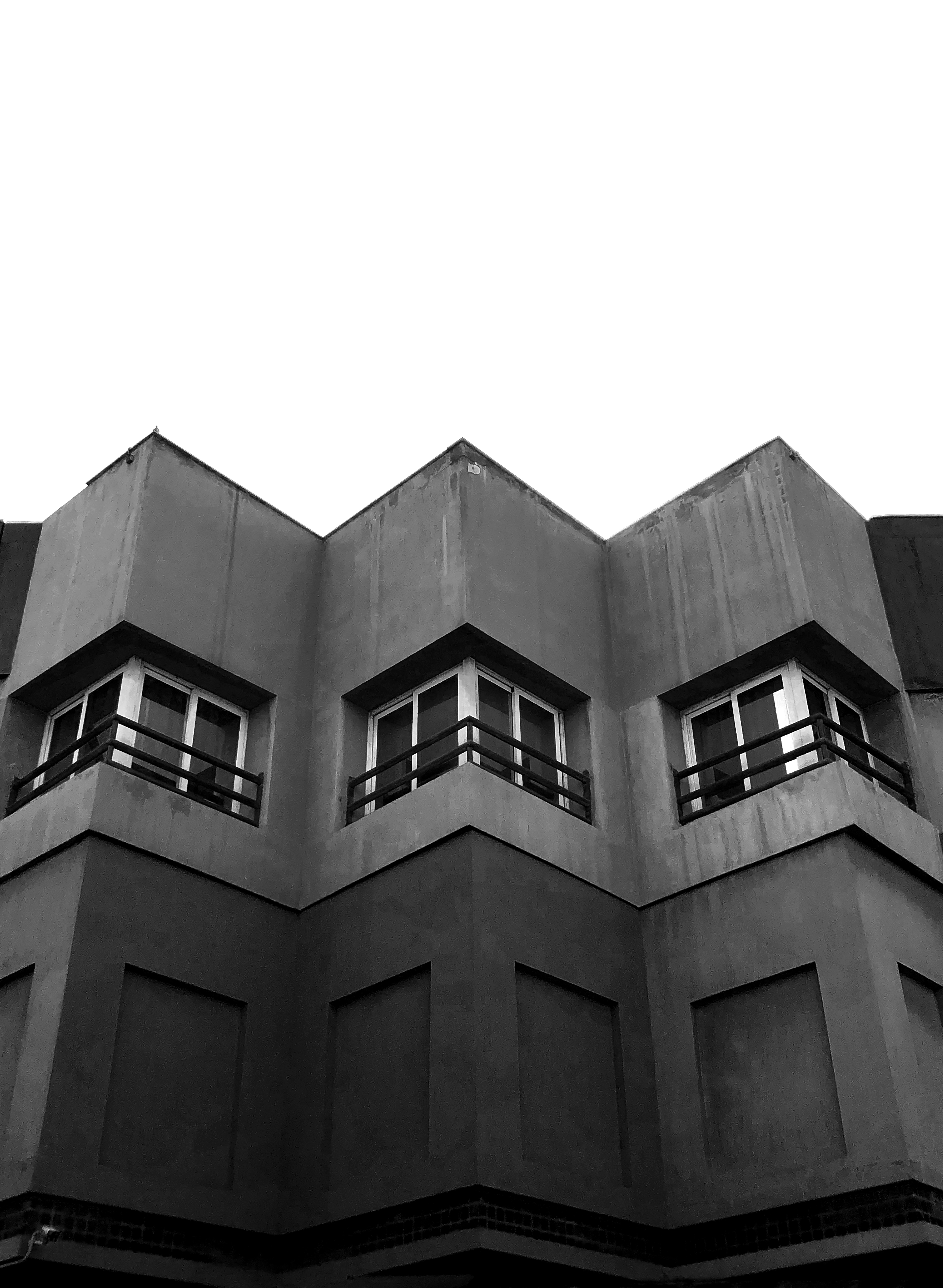 Zigzag Horizon: Repeated Window Niches on a Monochrome Concrete Facade