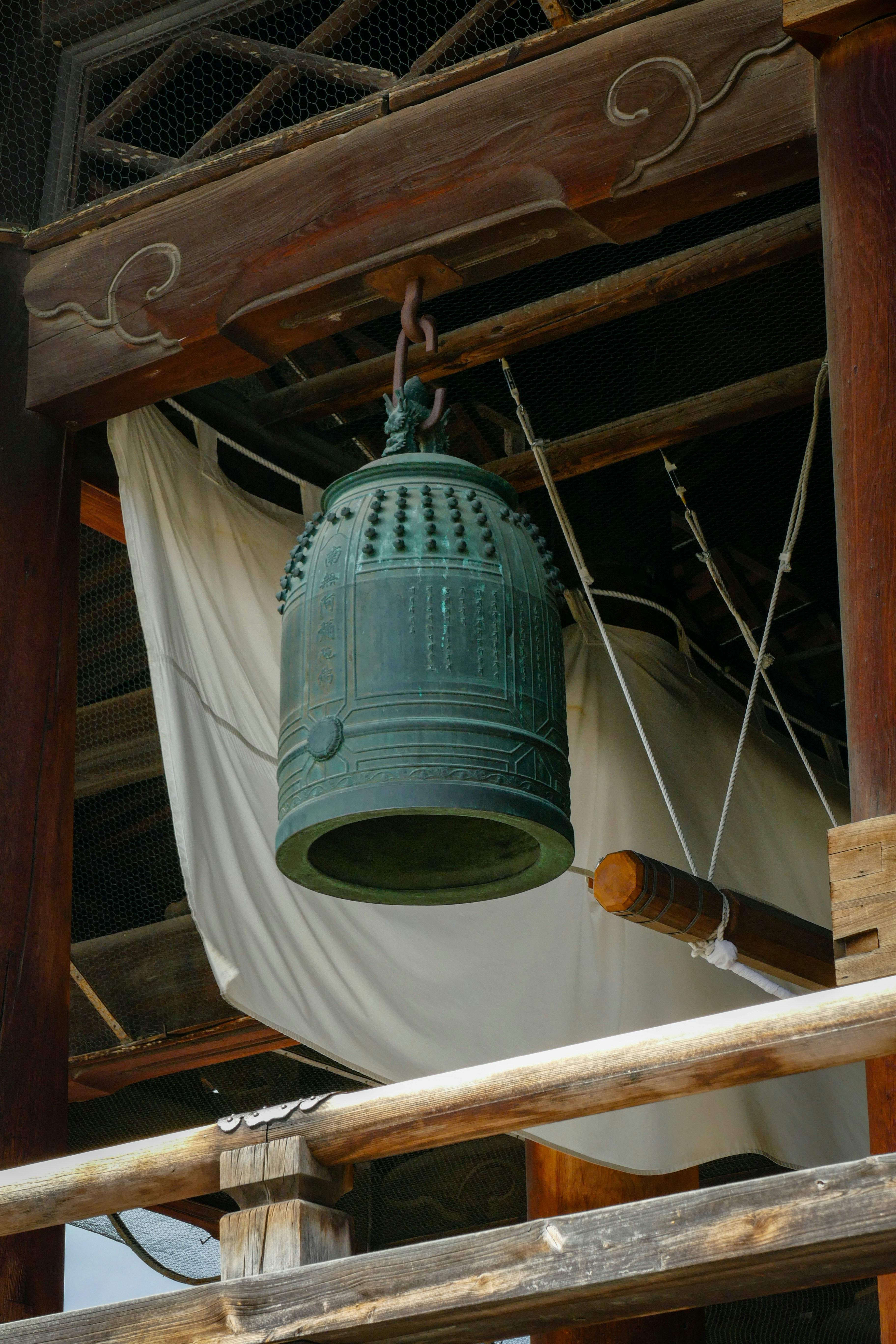 Verdigris Bell in a Timber Temple Atrium