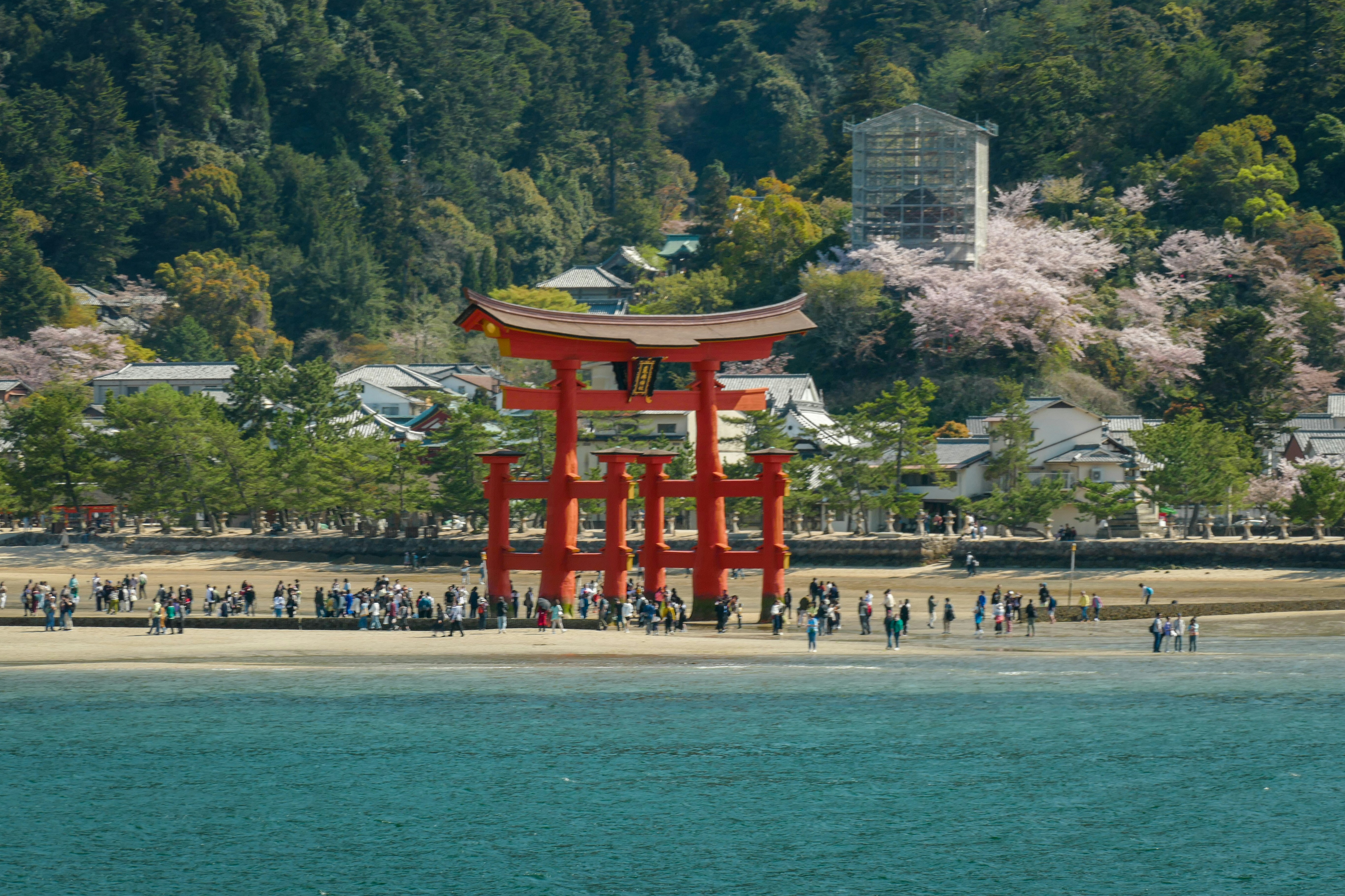 A large red tower sitting on top of a beach photo – Free Japan Image on ...