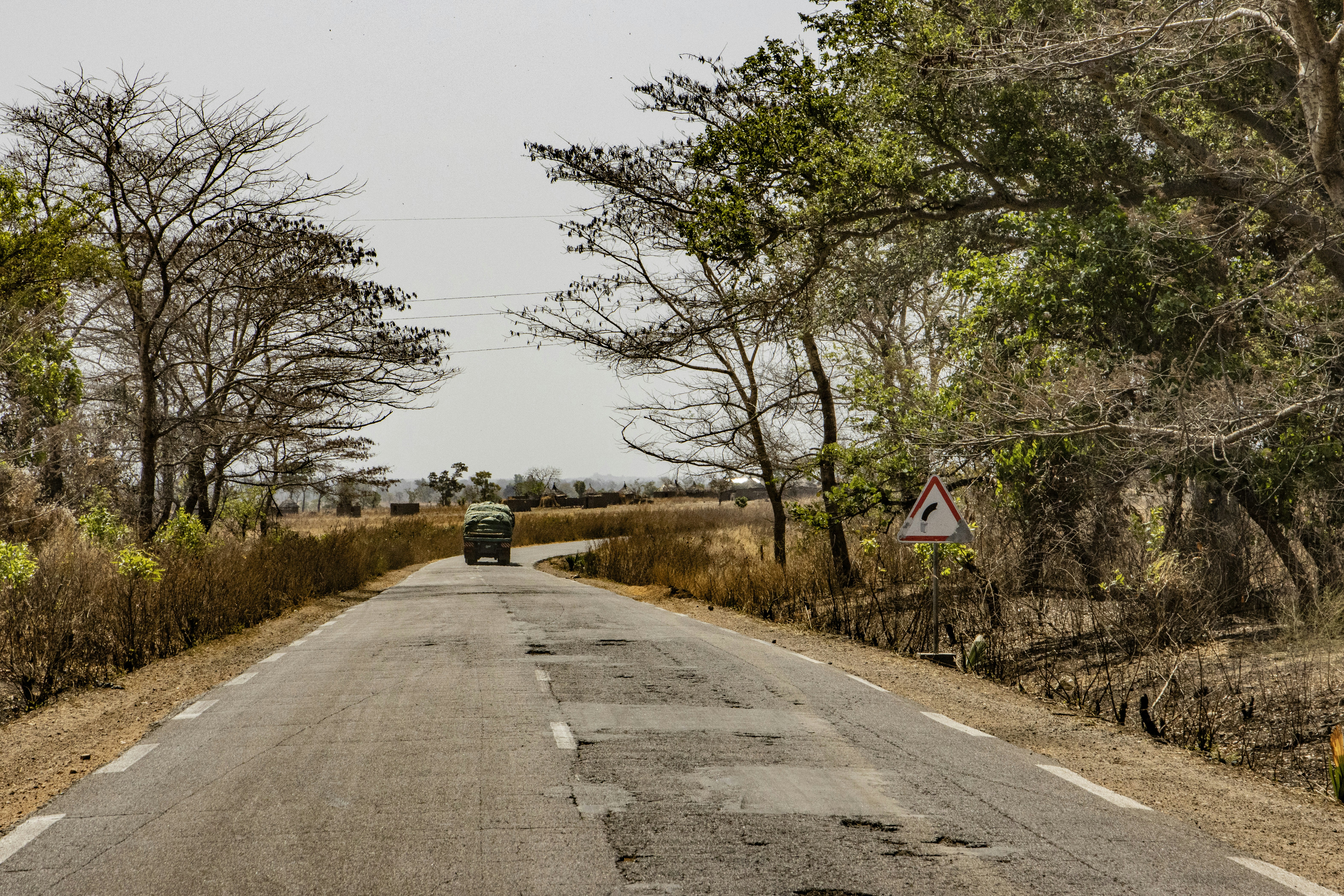 A car is driving down a deserted road photo – Free Camerun Image on ...