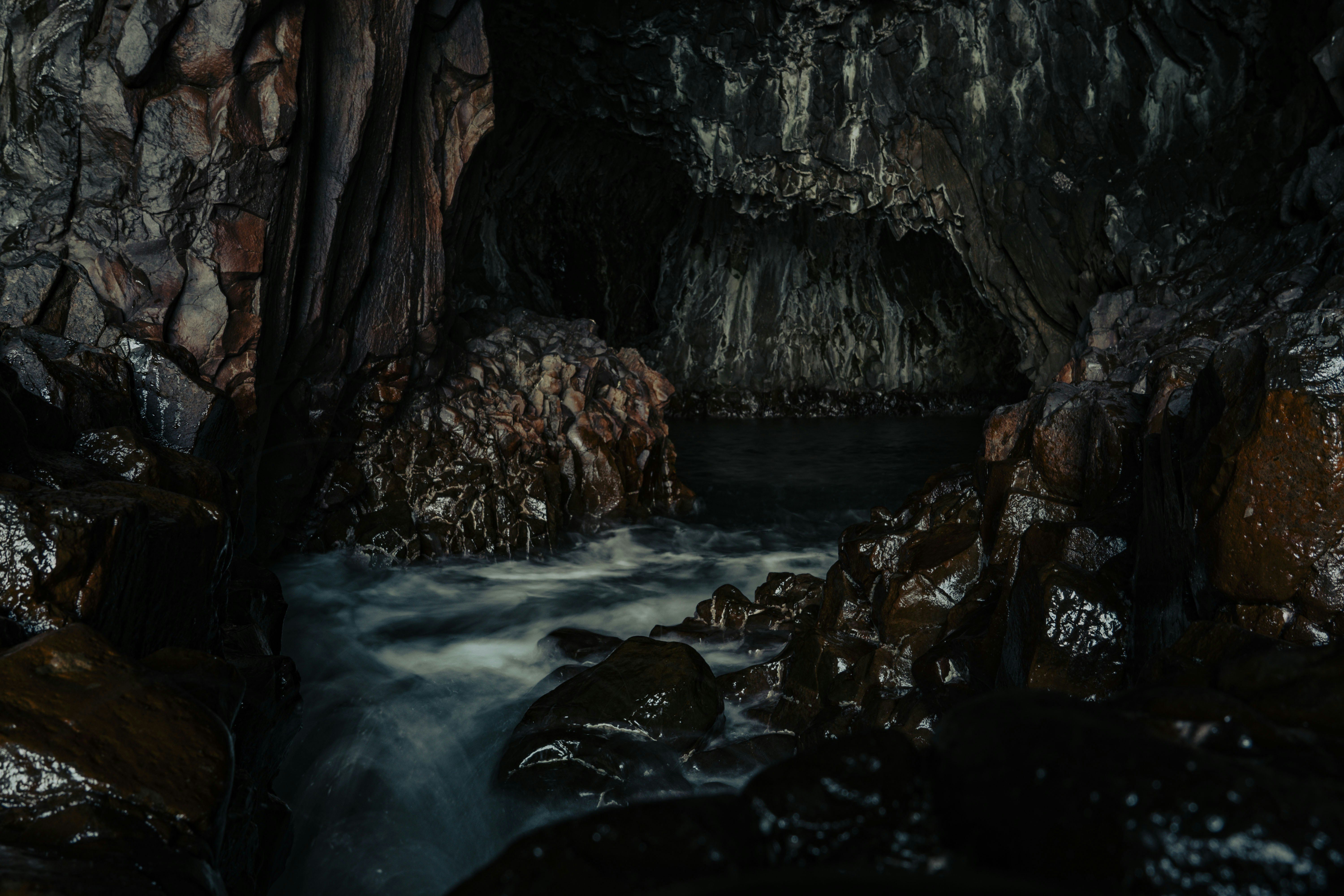 A stream running through a cave filled with rocks photo – Free Cave ...