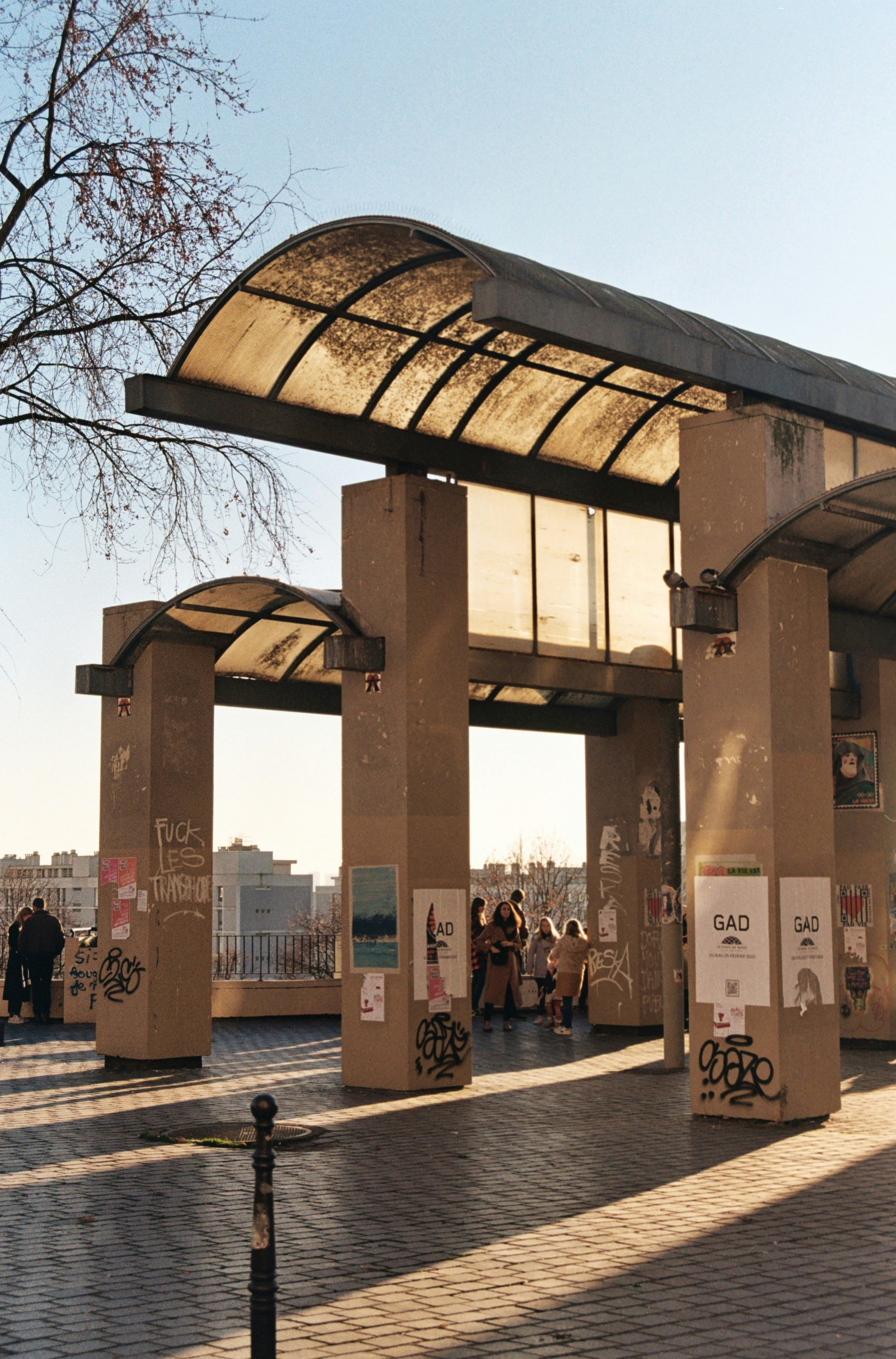 A group of people standing under a covered structure photo – Free ...
