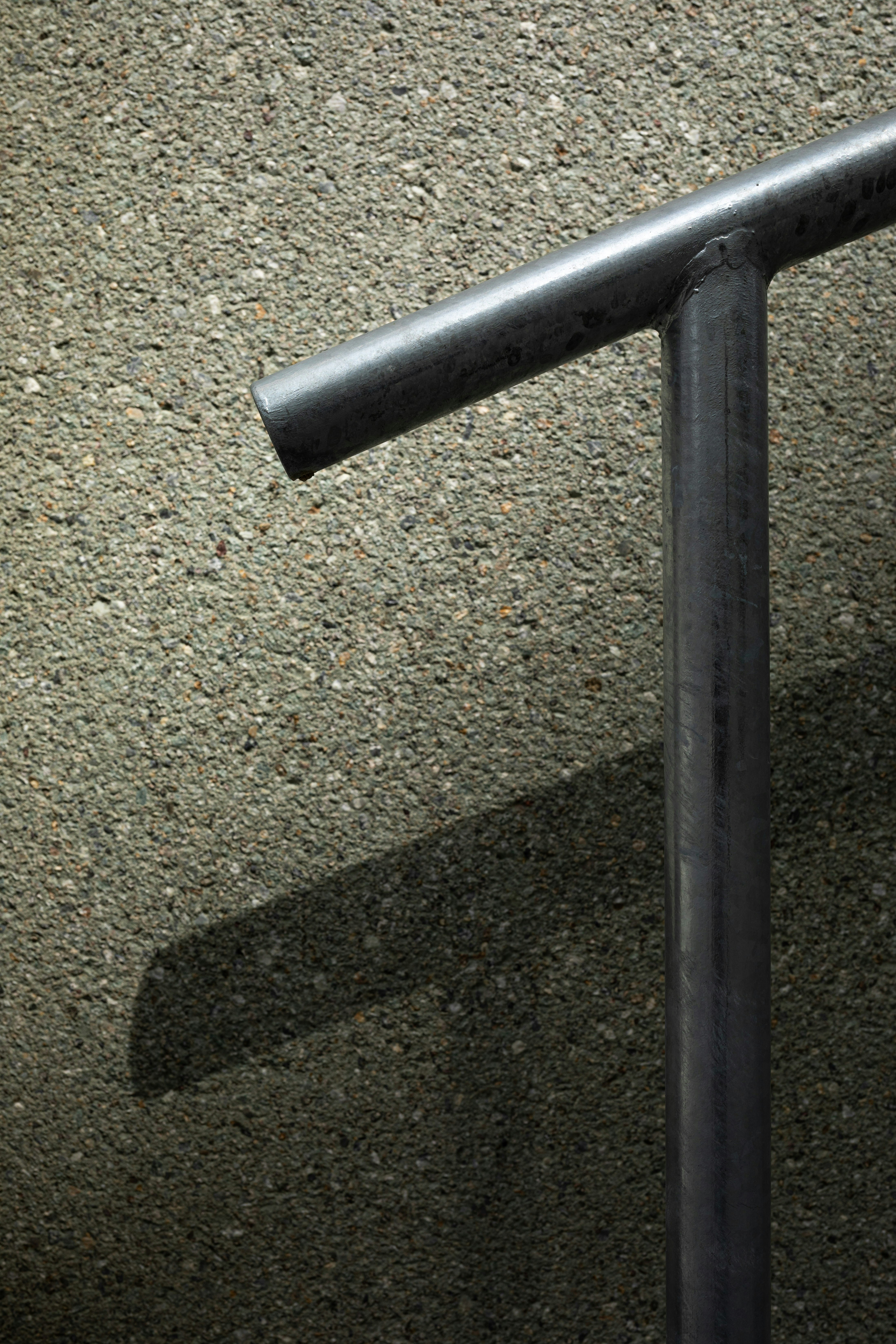 A close up of a metal rail on a concrete floor photo – Free Handrail ...