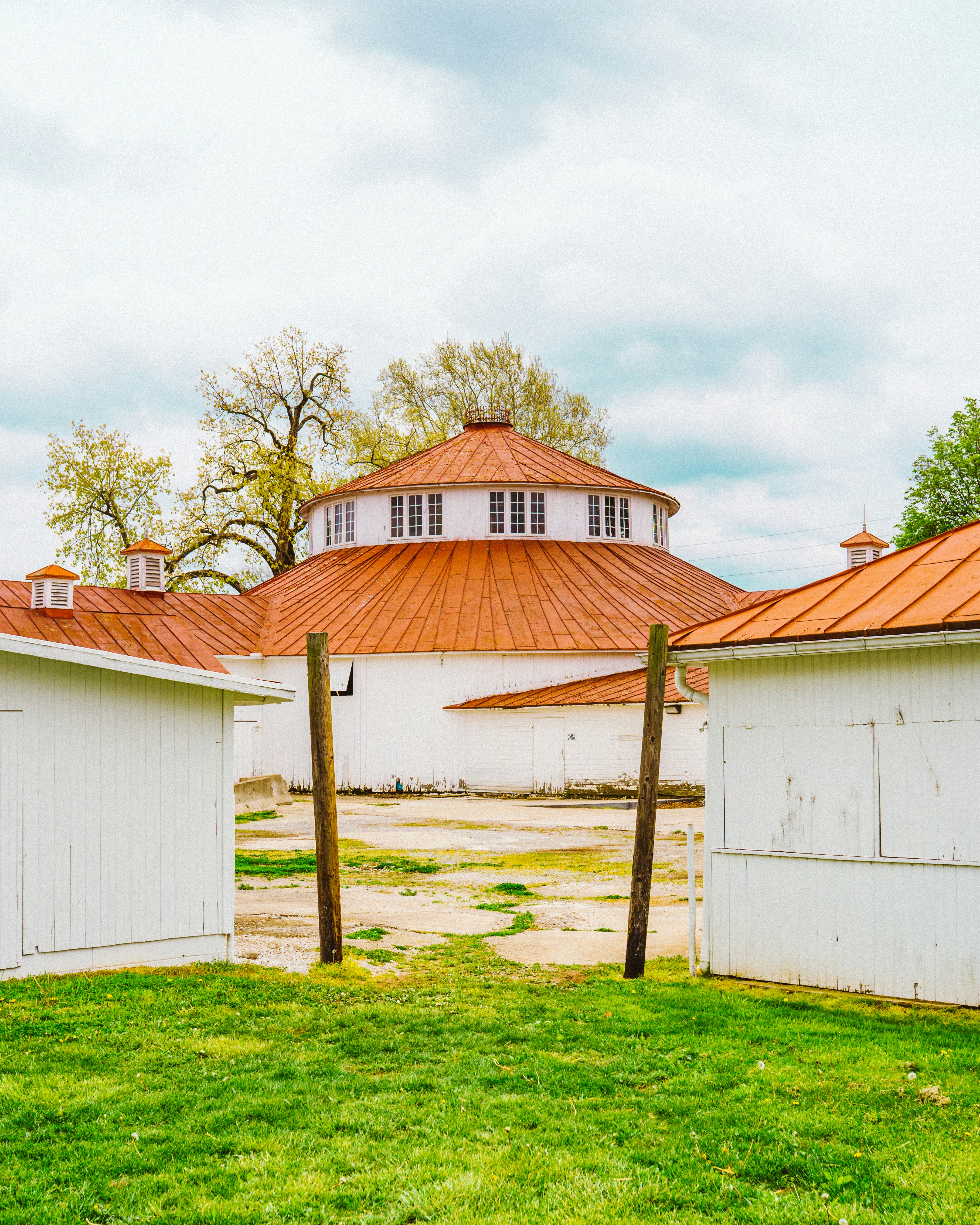 Crowned in Rust: A Circular Barn Framed by White Sheds