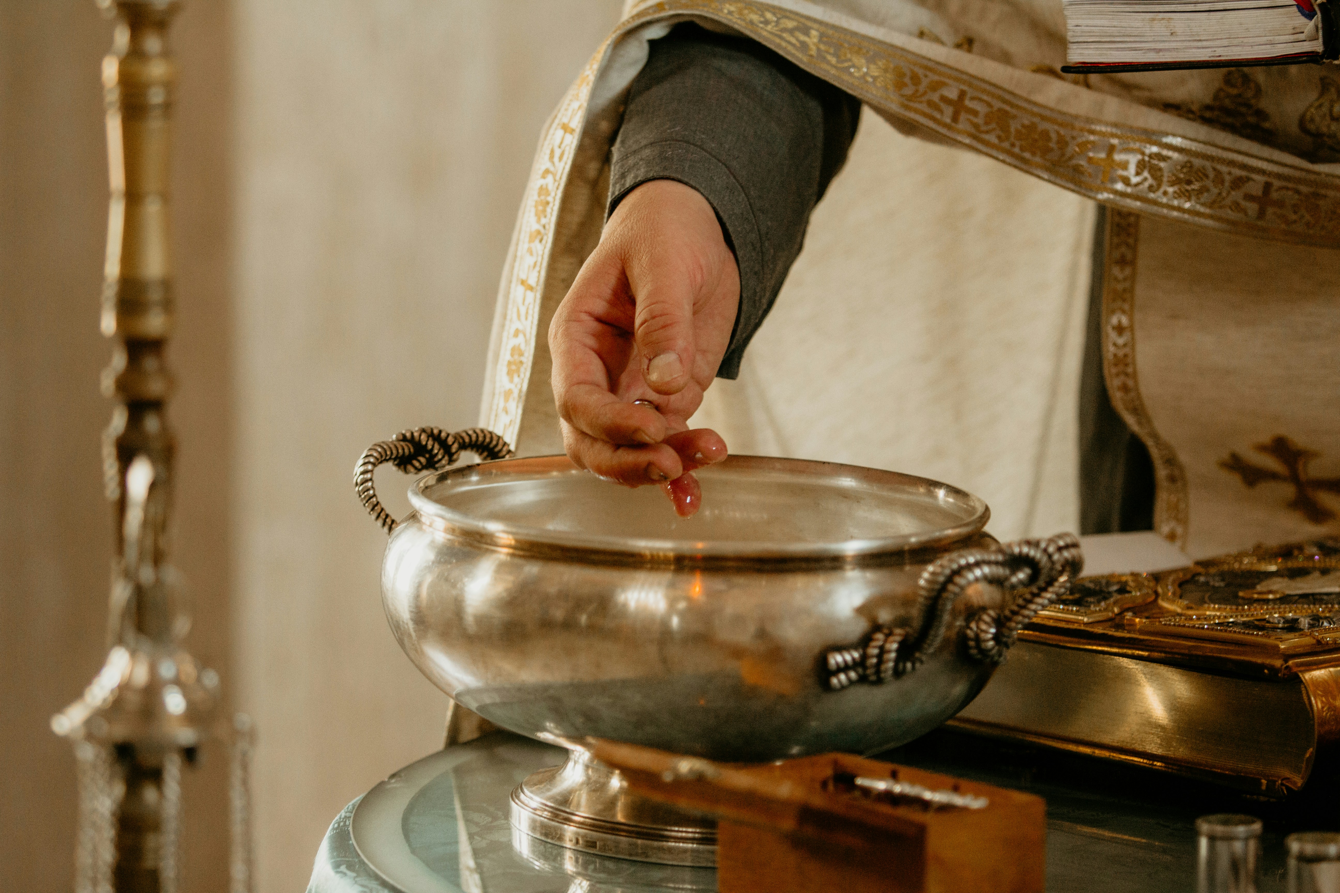 Silent Rite Over a Silver Basin in Warm Cathedral Light