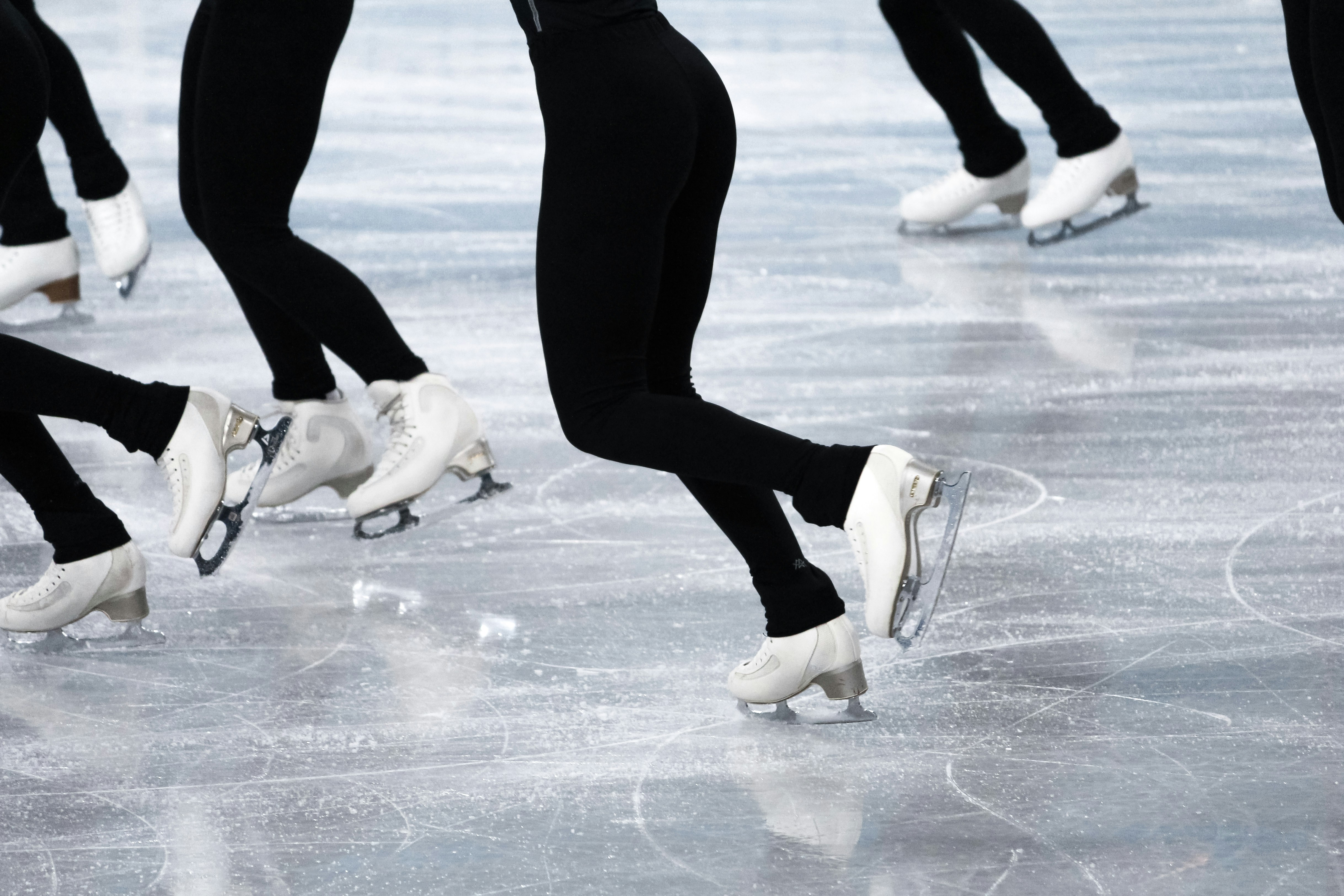 A group of people skating on an ice rink photo – Free Ice skating Image ...