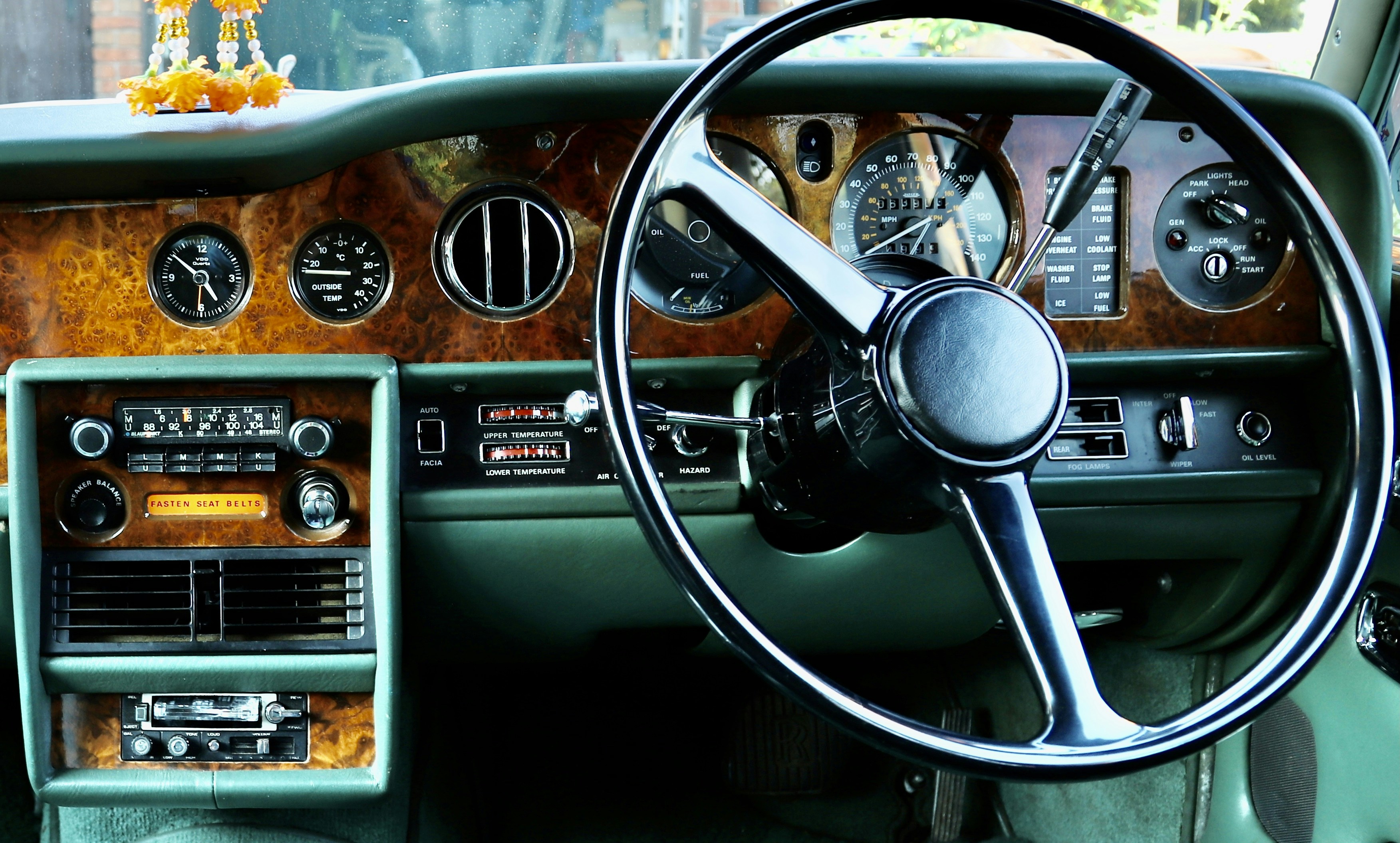 A car dashboard with a steering wheel and dashboard controls photo ...