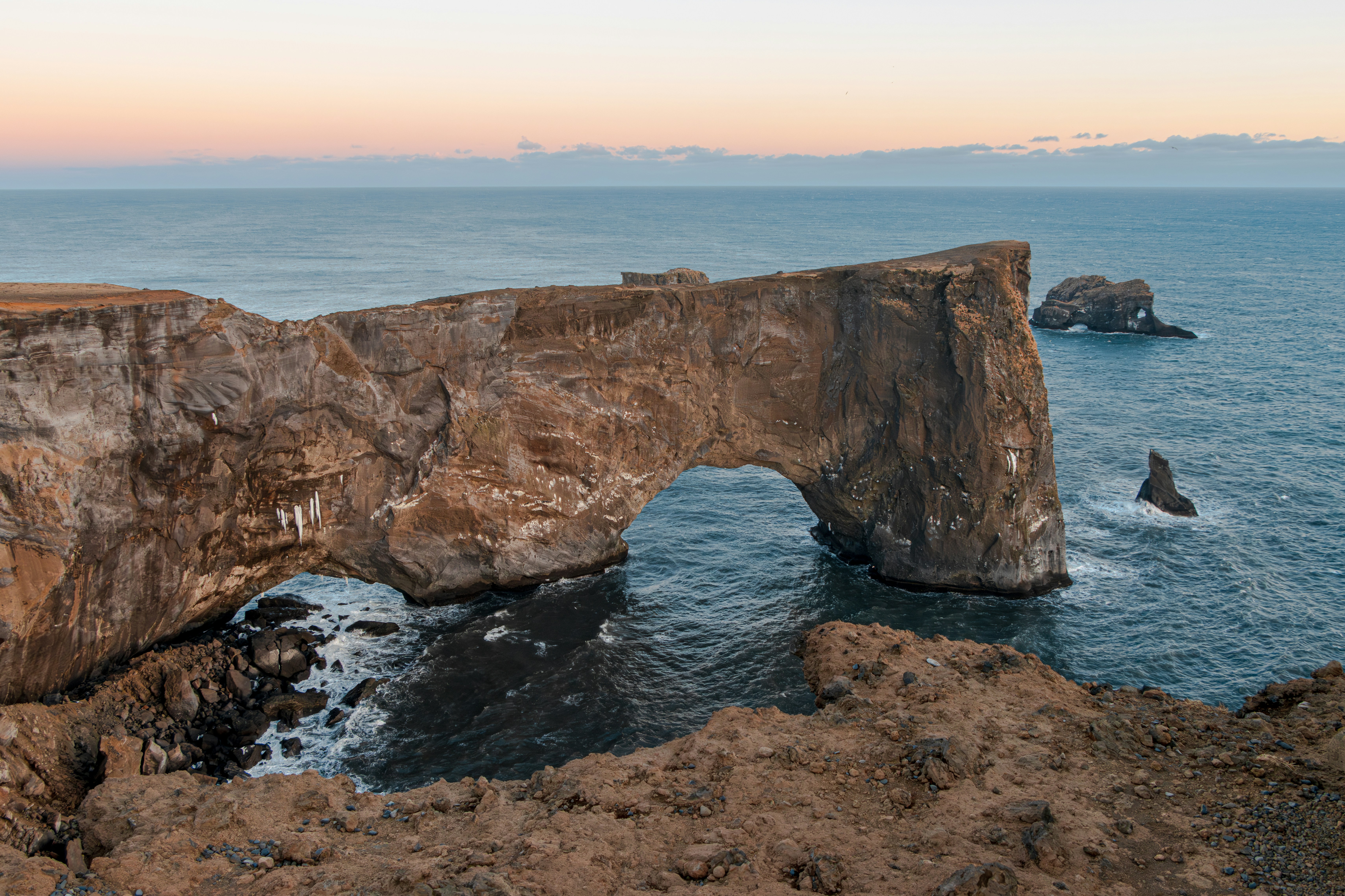 A large rock bridge over a body of water photo – Free Dyrhólaey Image ...