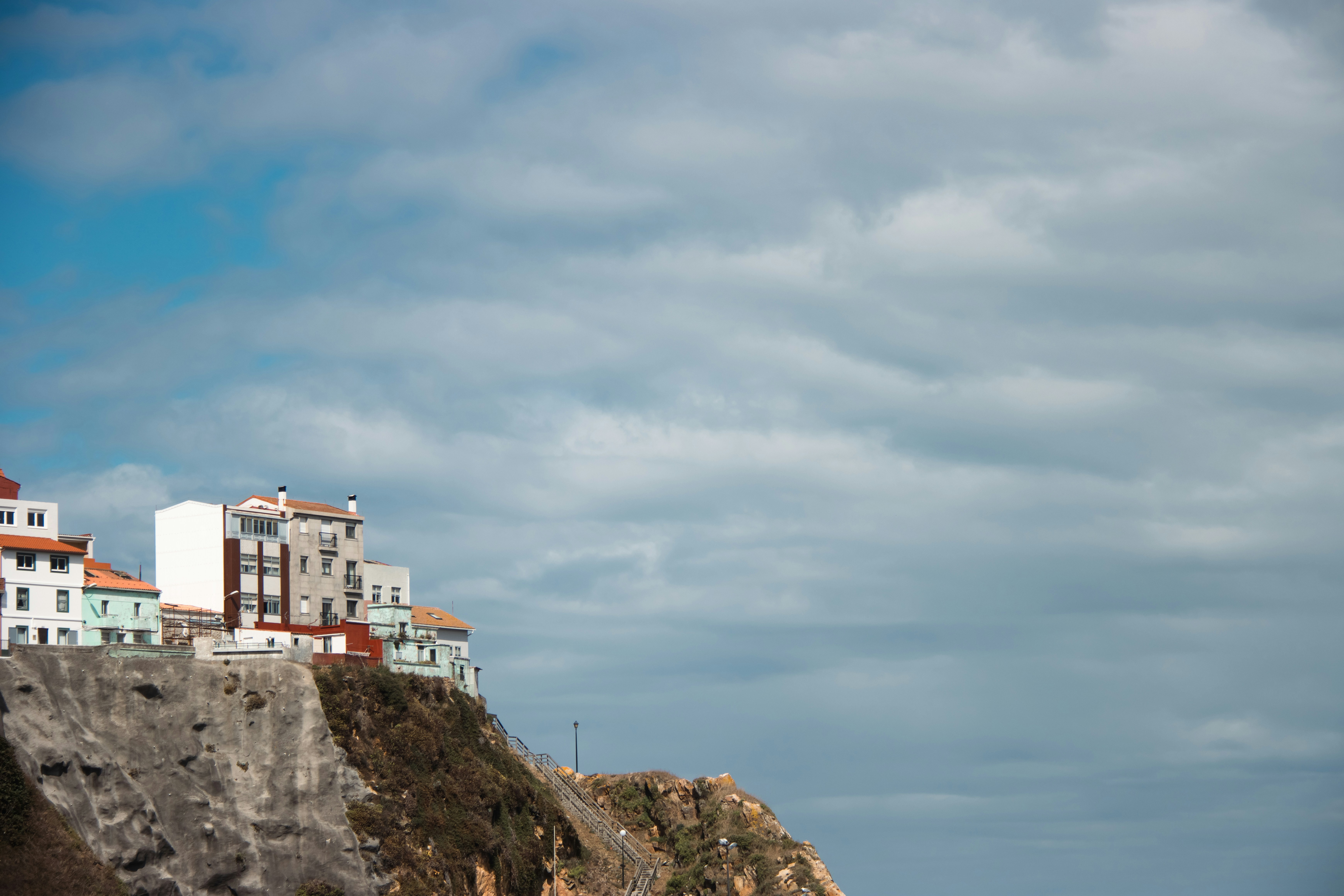 A city on a cliff overlooking the ocean photo – Free Spain Image on ...