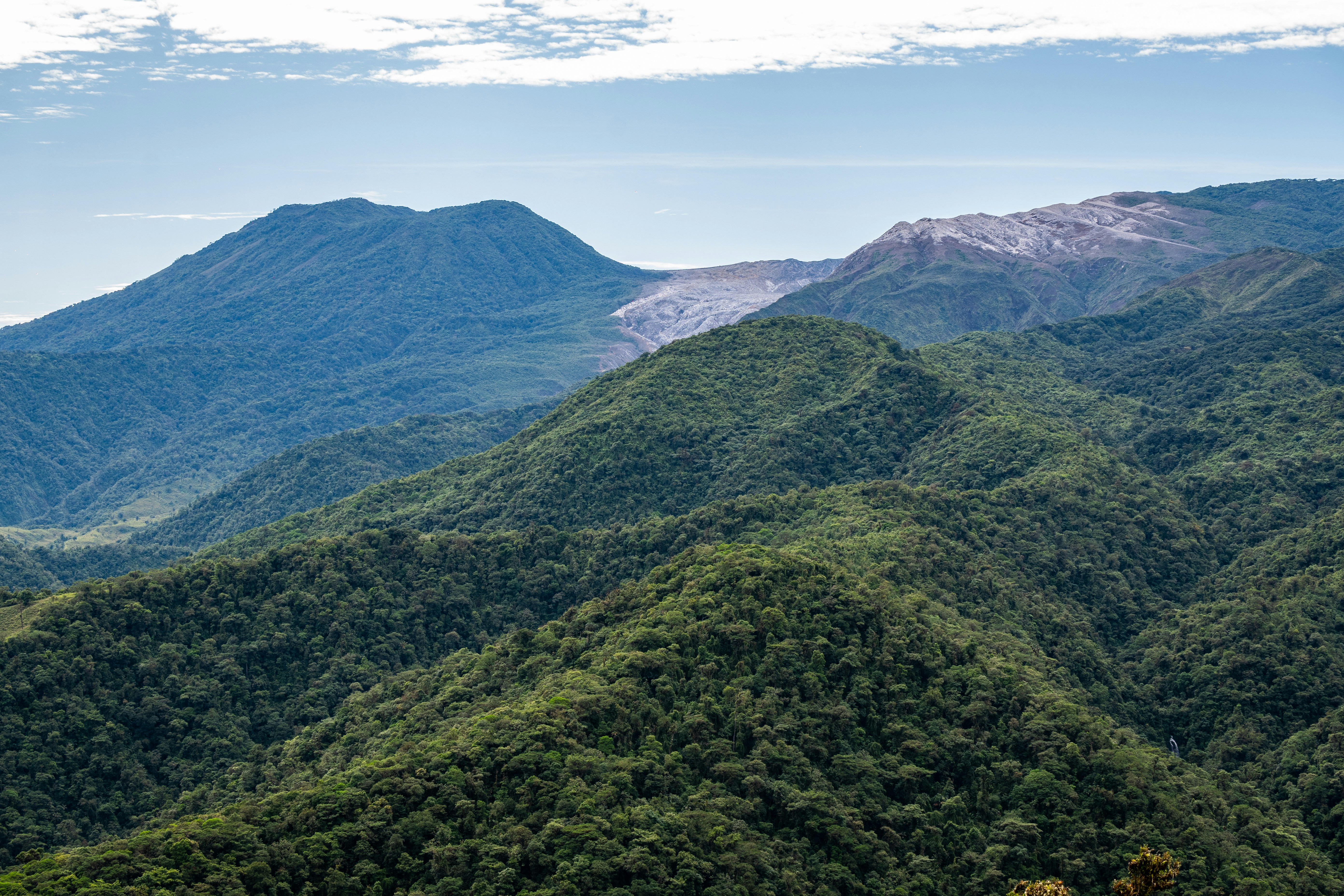 A view of a mountain range with trees and mountains in the background ...
